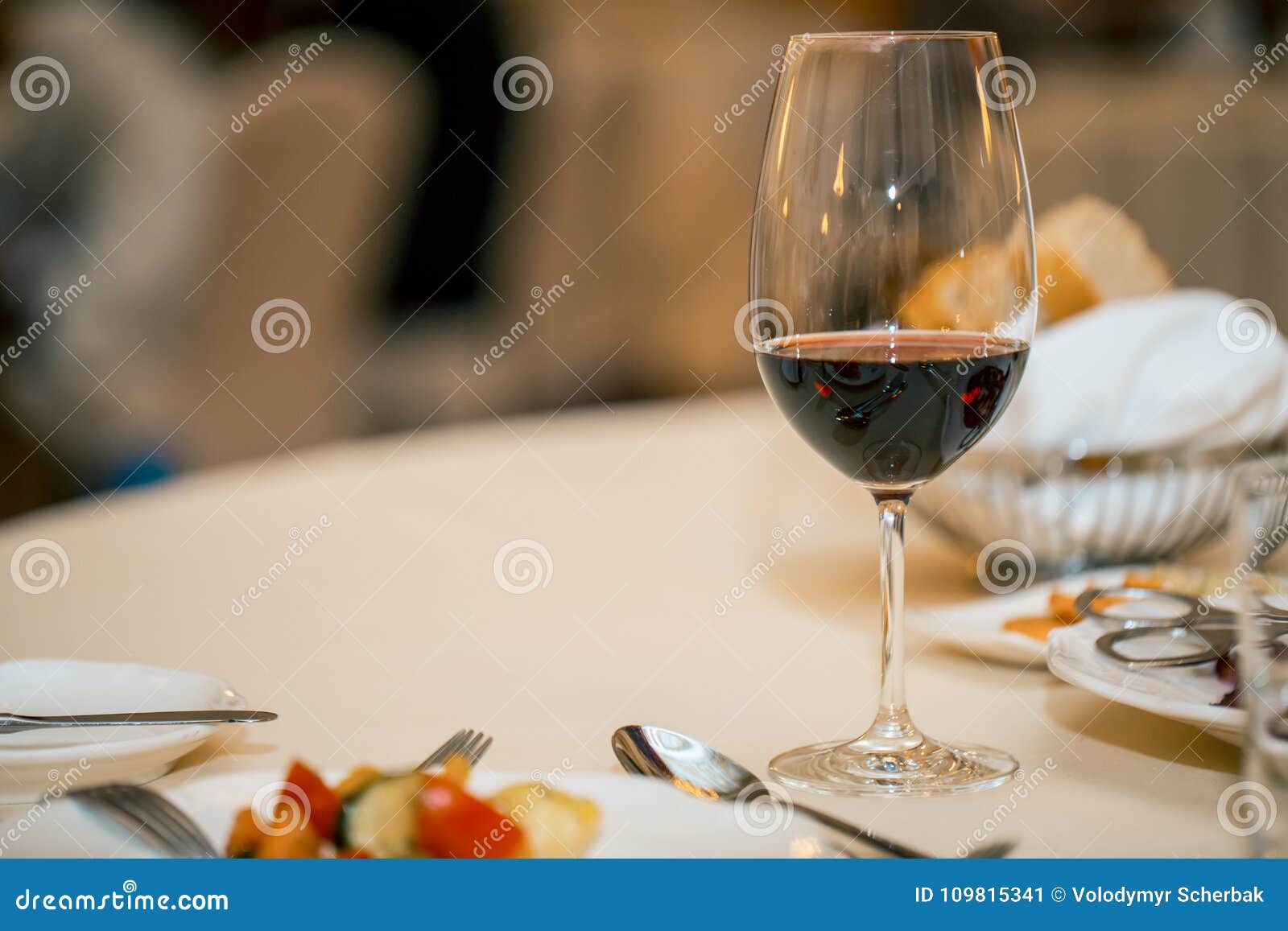 Glass of Red Wine and Dinner on a Set Table. a Restaurant. Waiting for ...