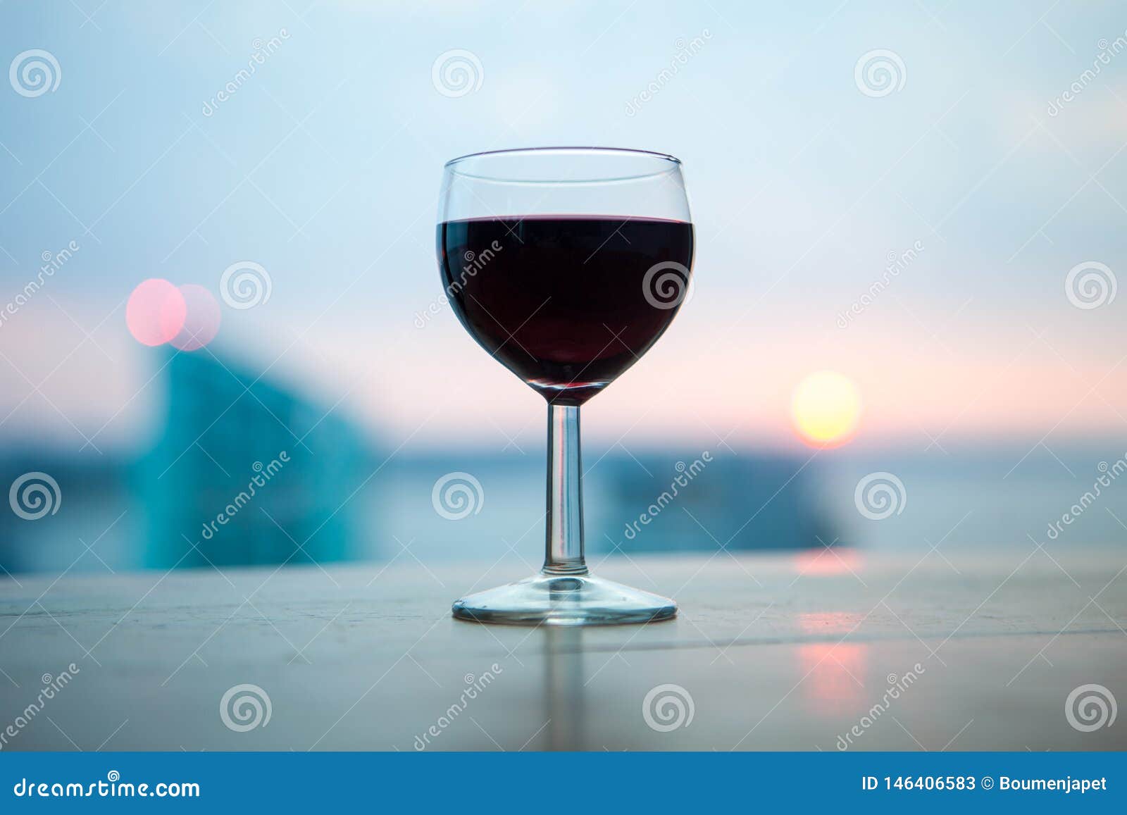 A Glass of Red Wine in Front of the Beautiful Soft Sunset. Stock Image ...