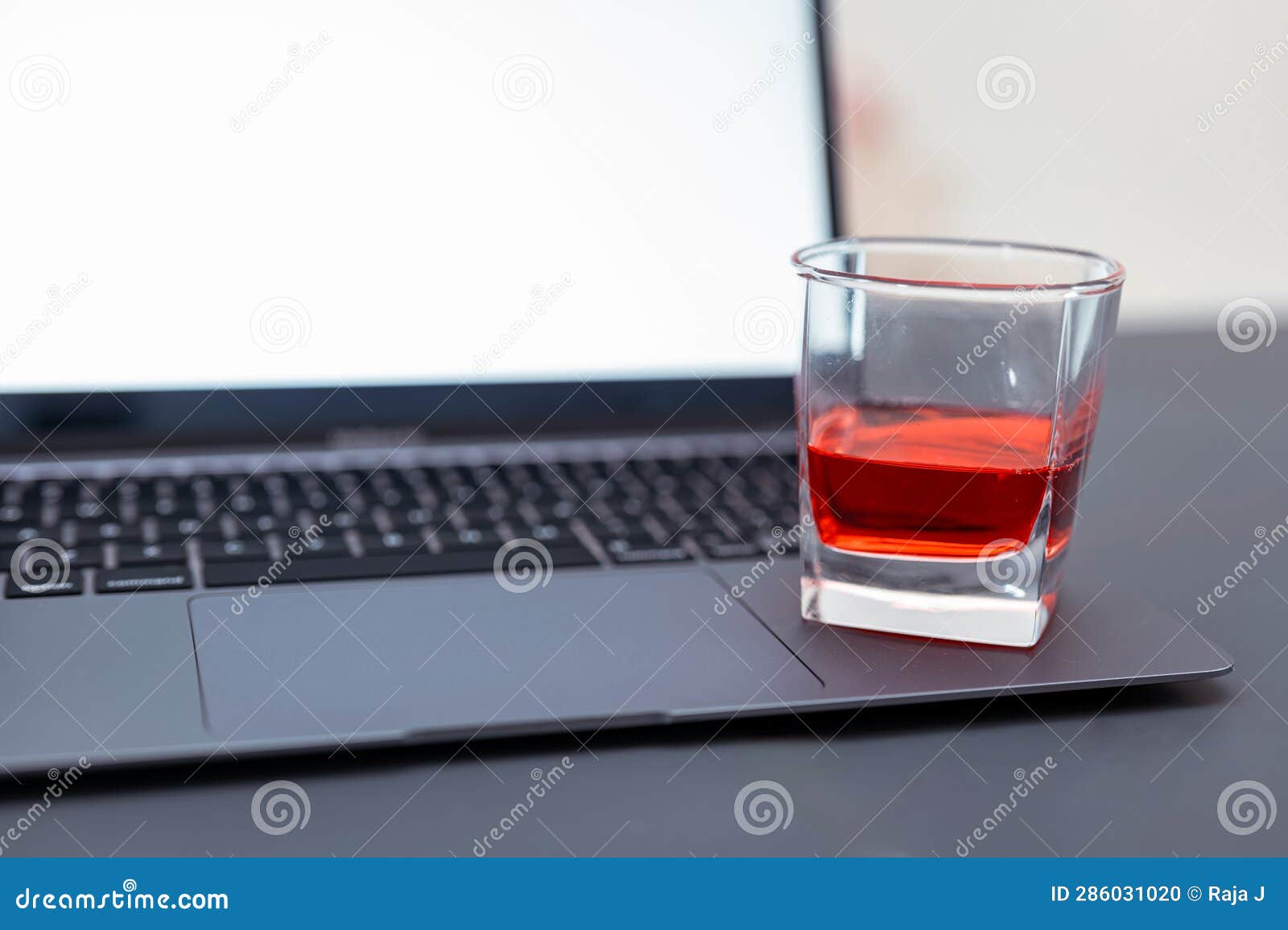 A Glass of Red Wine Sitting on Top of a Laptop Computer Stock Photo ...