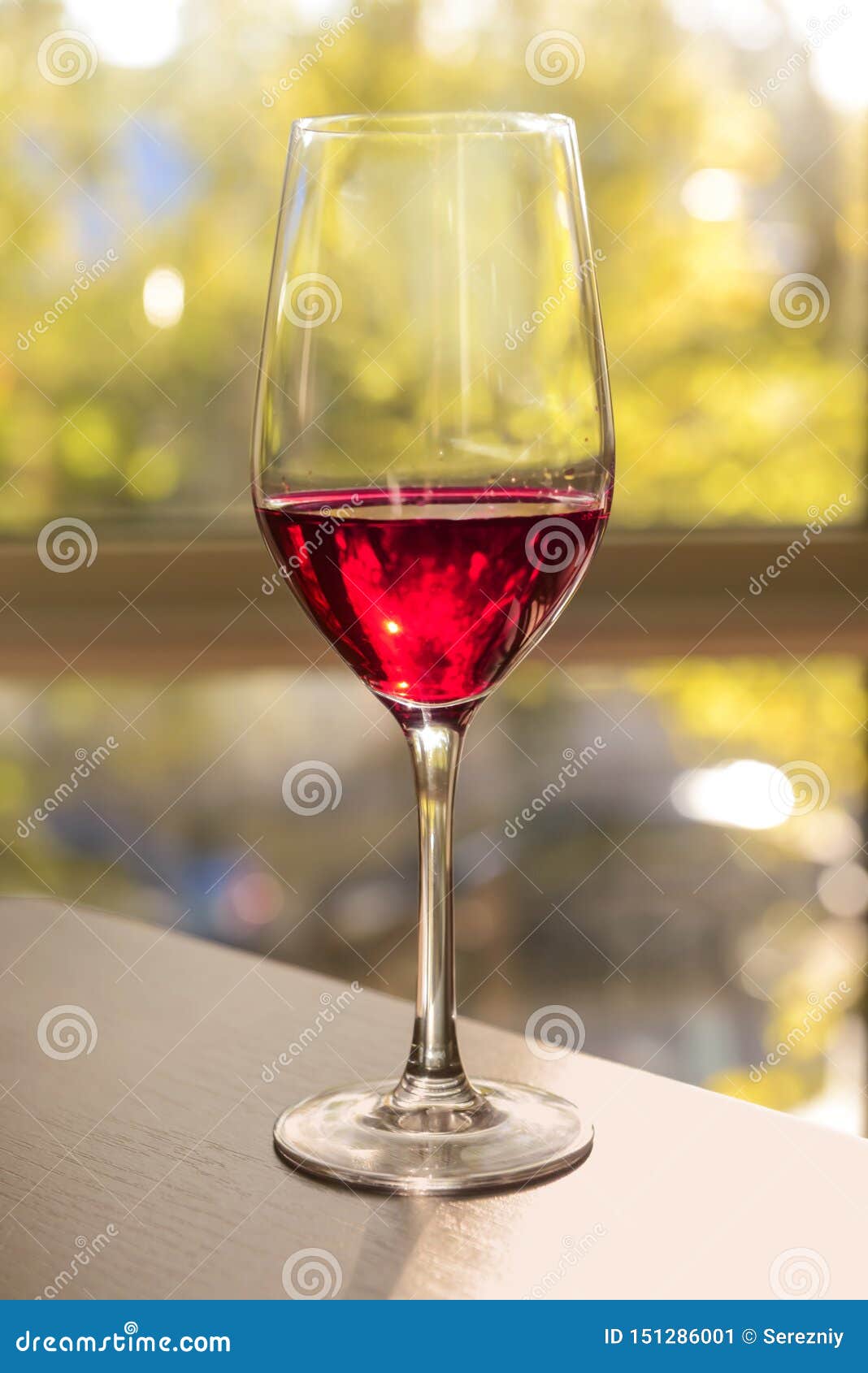 Glass of red wine on table stock image. Image of wineglass - 151286001
