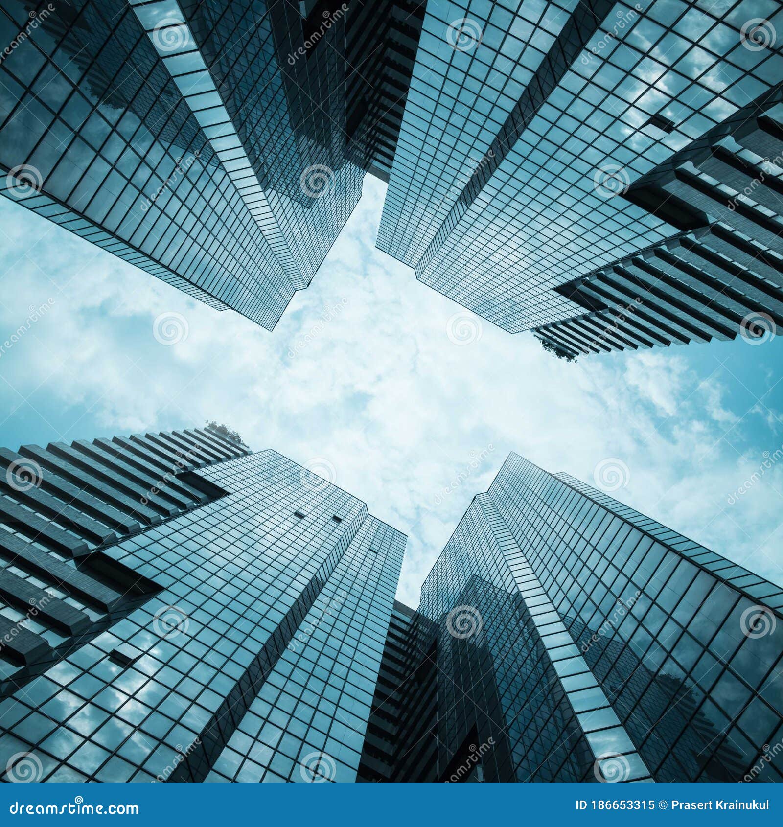 Glass Reflective Office Buildings Against Blue Sky with Clouds and Sun ...