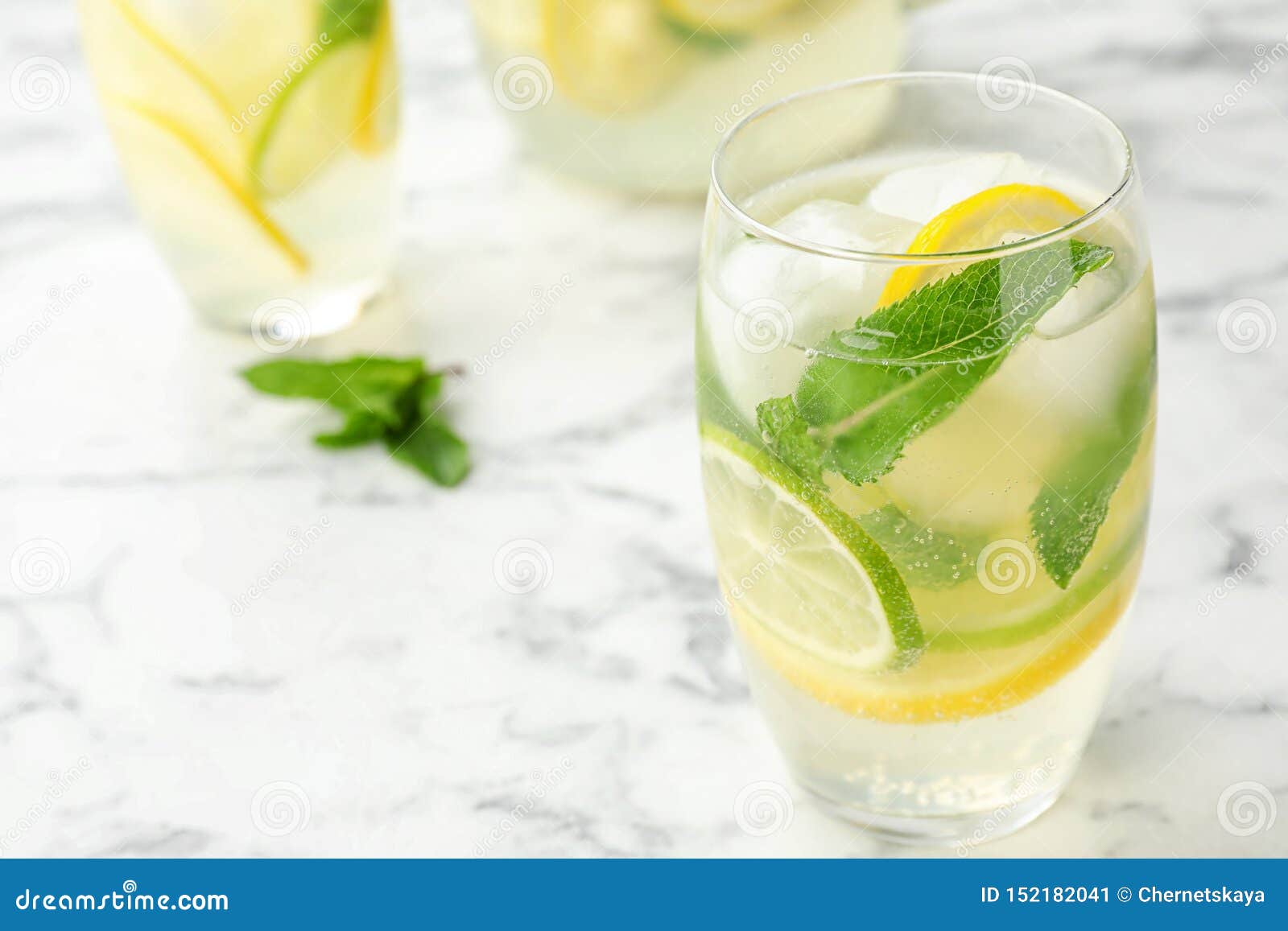Glass of Refreshing Lemonade on Marble Table, Space for Text. Summer ...