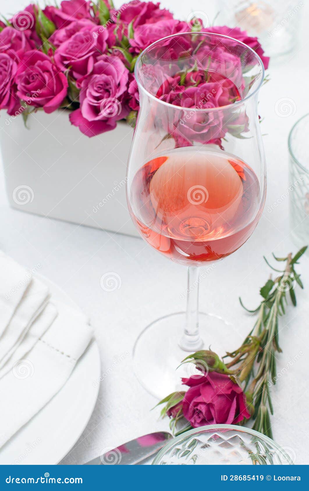 Glass of Rose Wine and Festive Dining Table Setting with Pink Roses ...