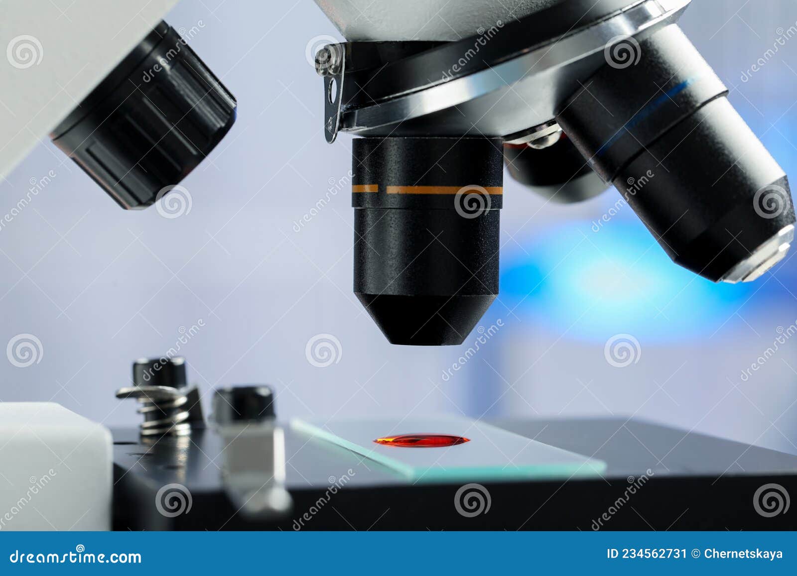 Glass Slide with Sample of Red Liquid Under Microscope in Laboratory ...