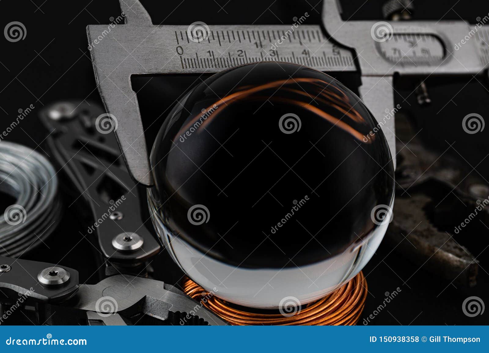 A Glass Sphere Being Measured with a Caliper with Tools Around it on ...