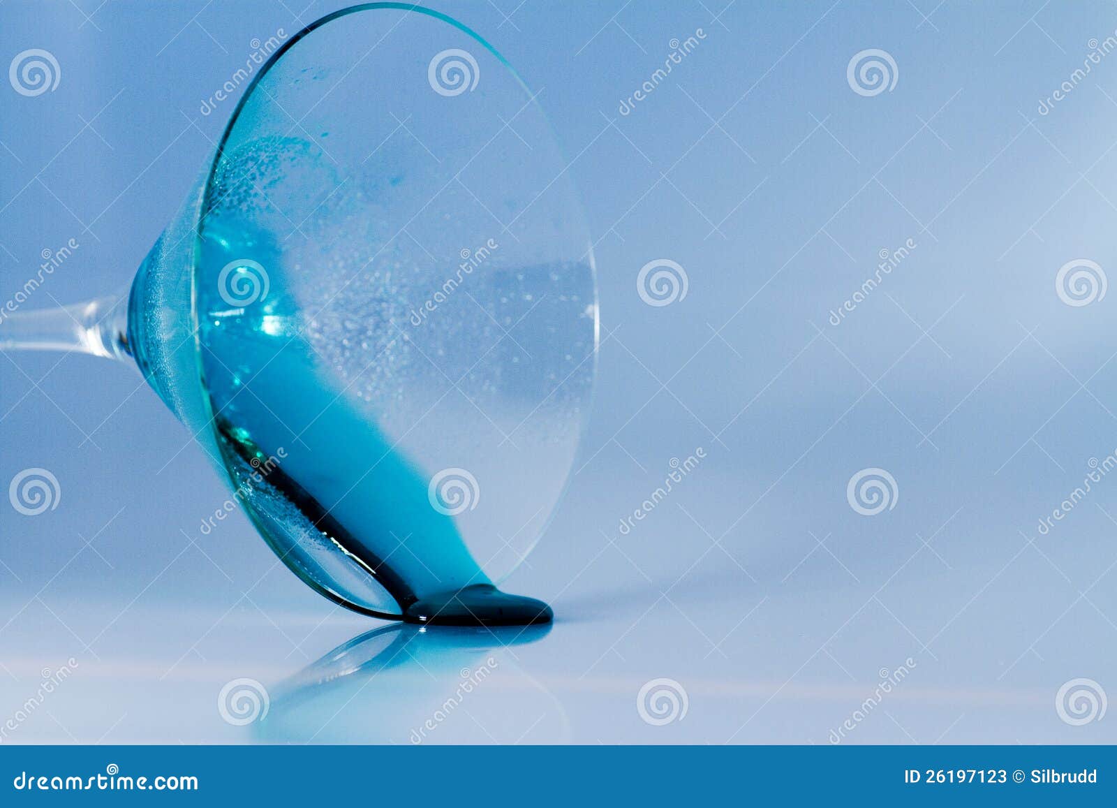Glass spilling blue liquid stock image. Image of trickle - 26197123