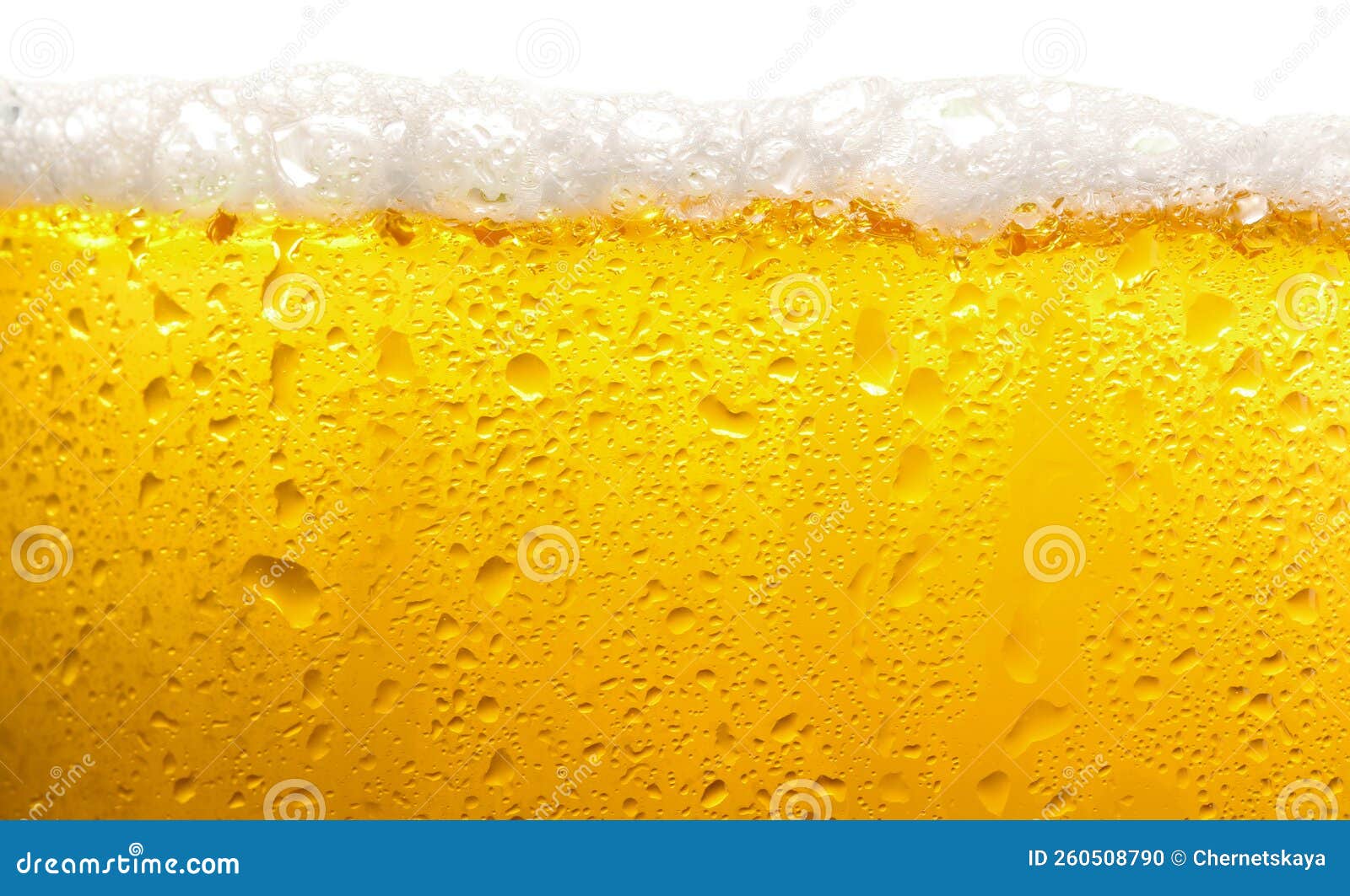 Glass Of Tasty Cold Beer With Foam And Condensation Drops On White