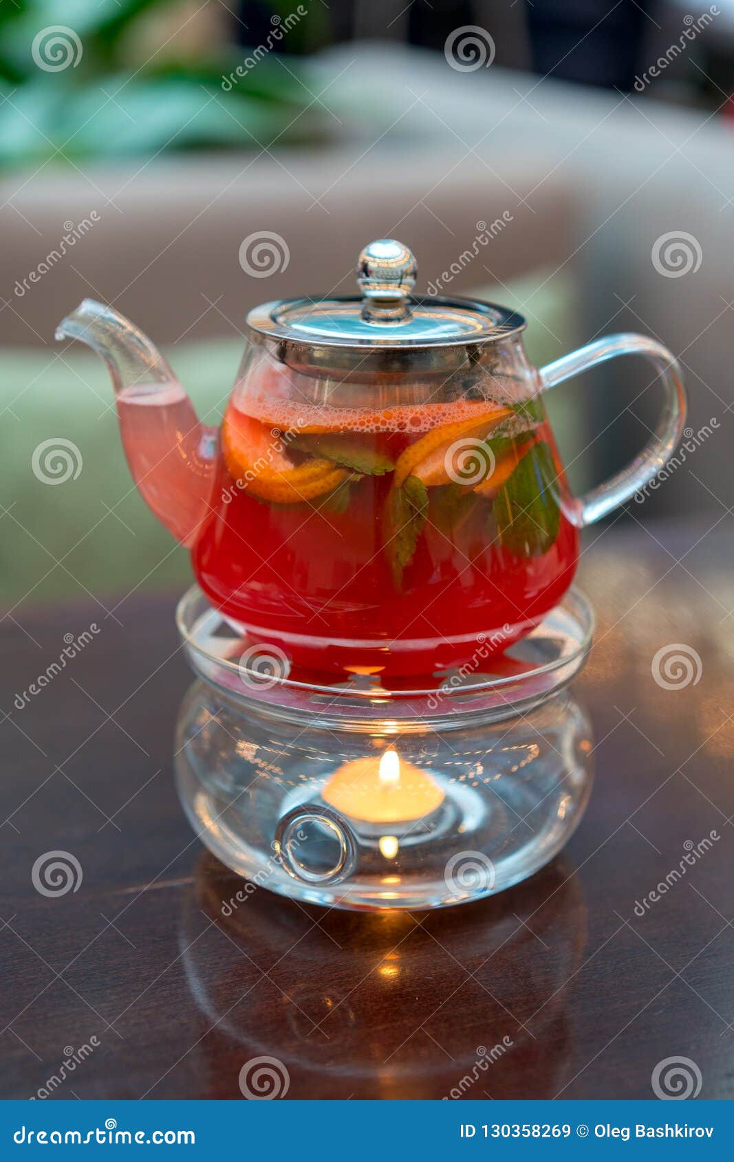 A Glass Teapot with Grapefruit Tea Blows from the Flame of a Can Stock ...