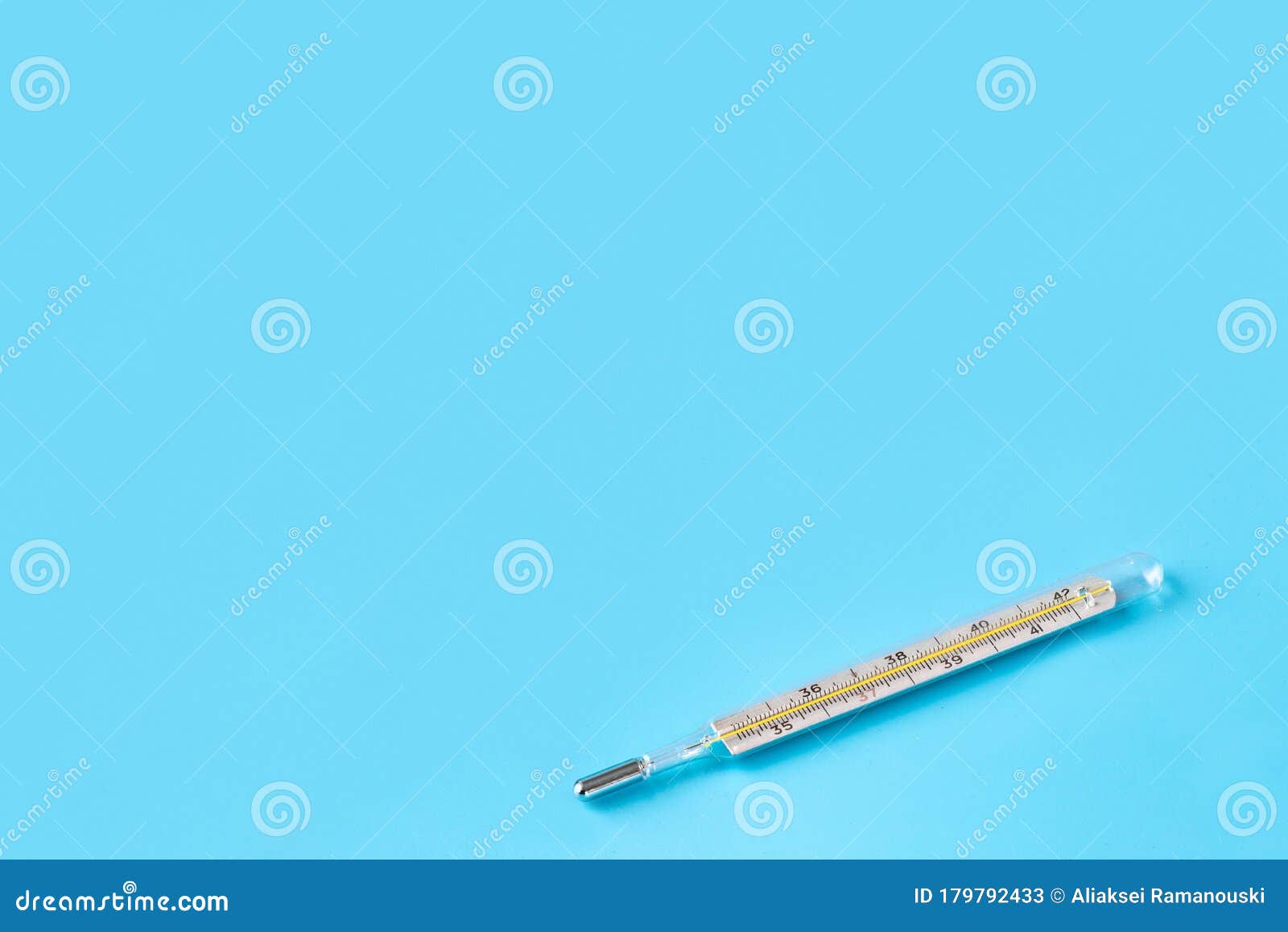Glass Thermometer for Measuring Body Temperature on a Blue Background ...