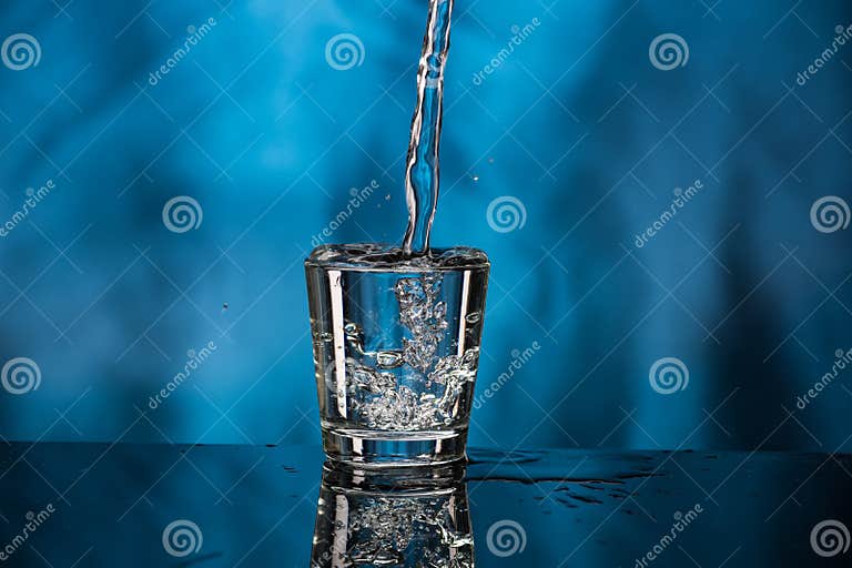 Glass with Vodka and a Big Splash on a Colored Background Stock Photo ...
