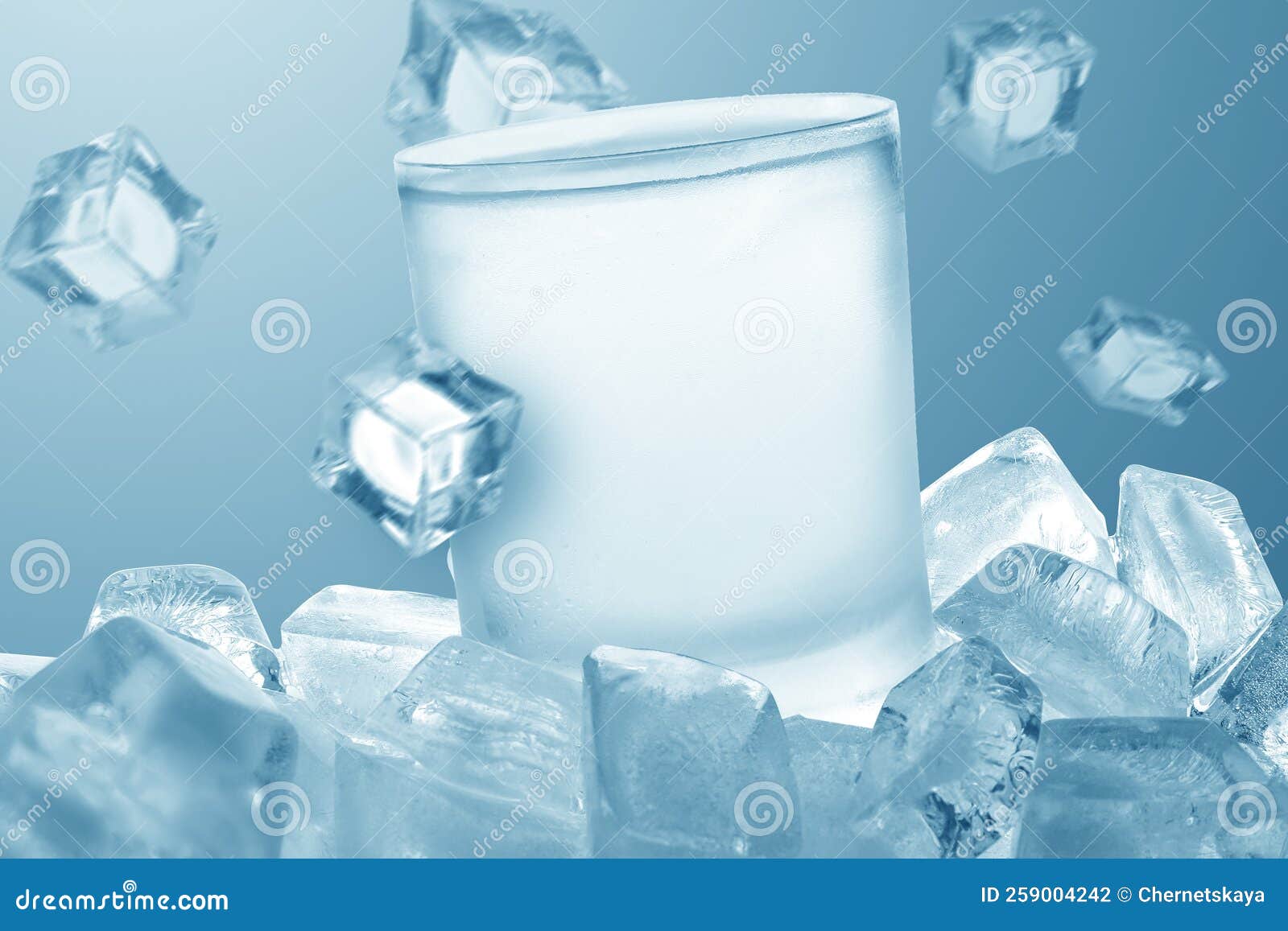 Glass of Vodka and Ice Cubes on Light Blue Background Stock Photo ...