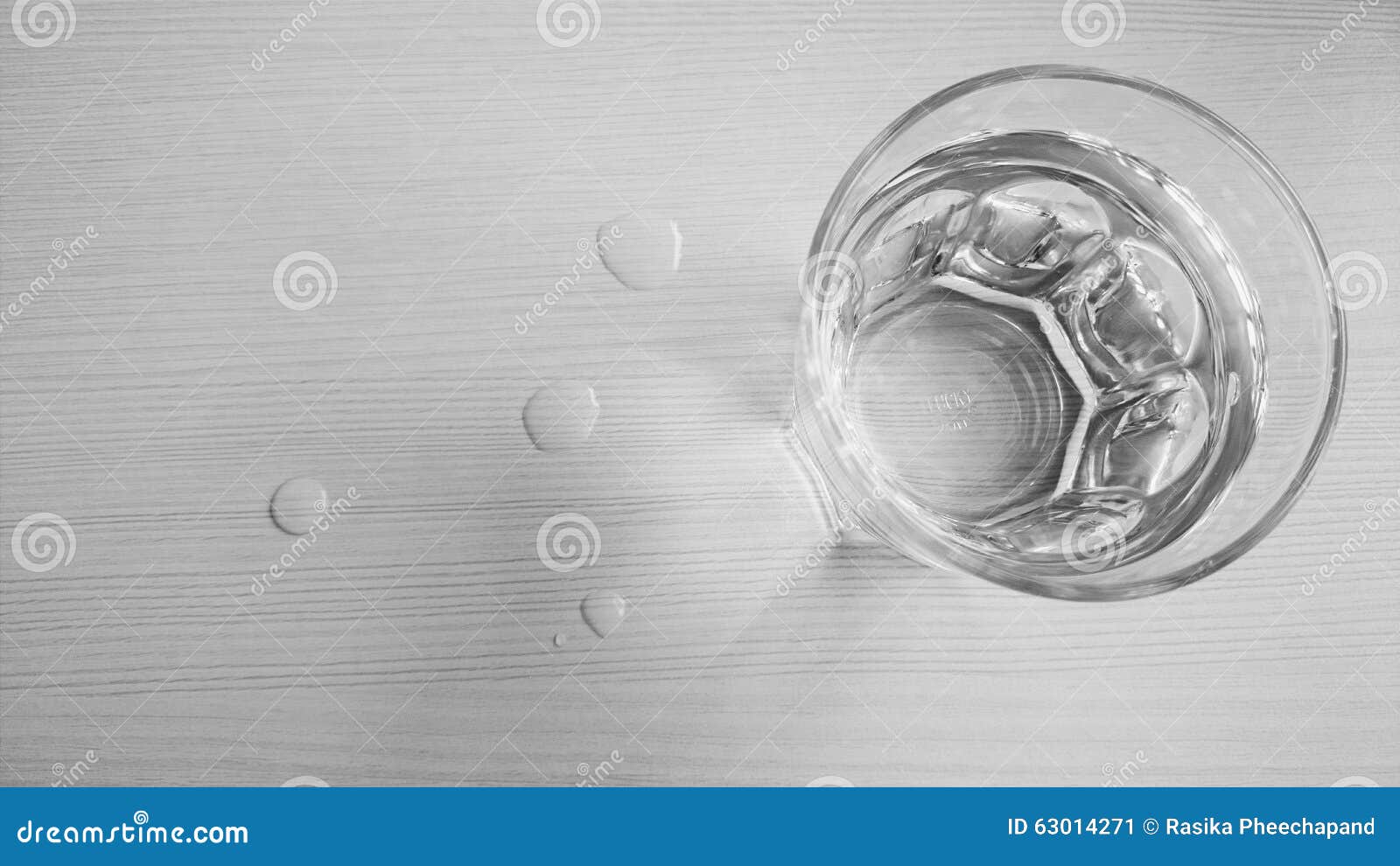 A Glass of Water with a Water Drops on White Wood Table Stock Image ...