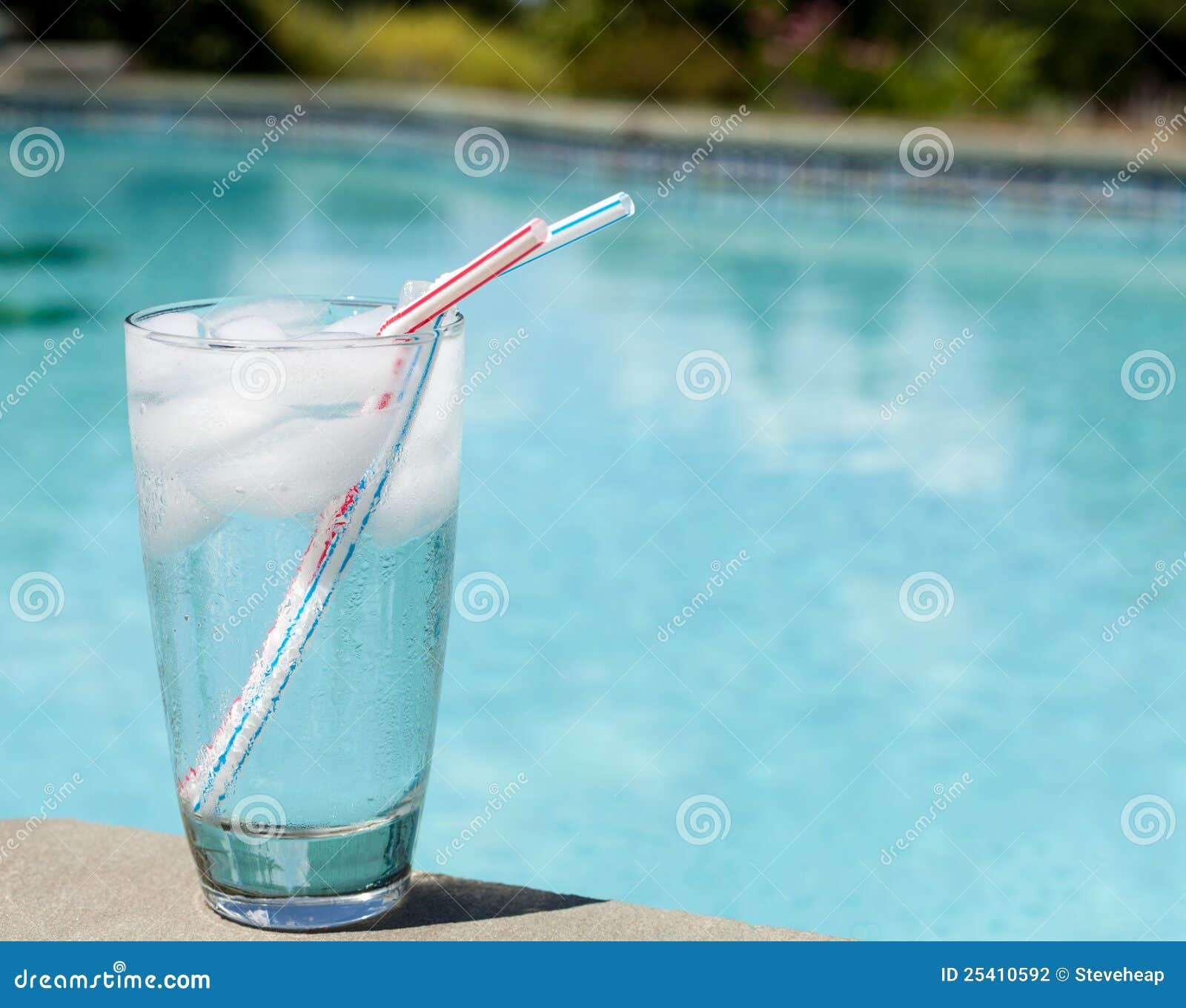 Glass of Water with Ice Cubes on Side of Pool Stock Photo - Image of ...