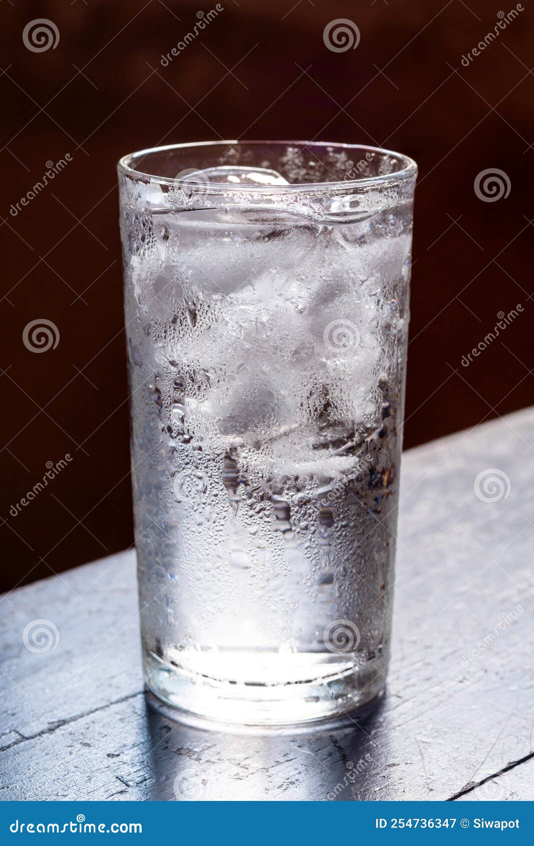 Glass Of Water With Ice On Wooden Dark Natural Light Stock Image