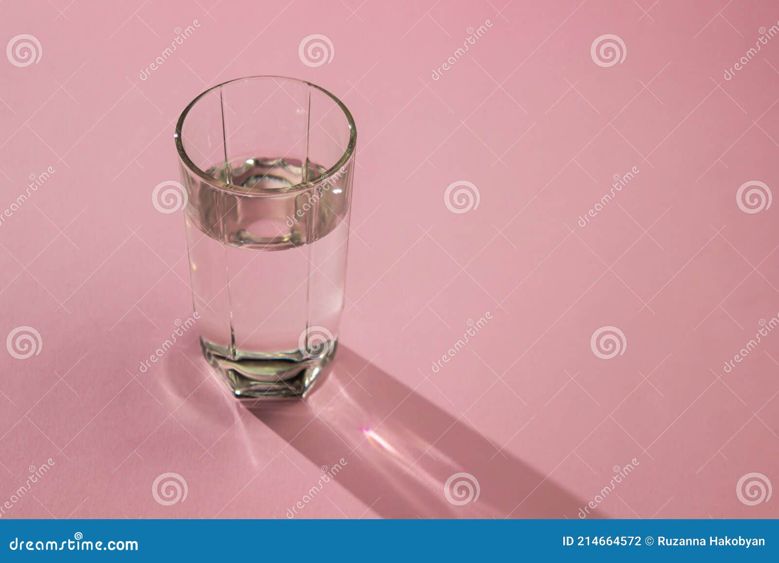 Glass of Water on a Pink Background. Clean Drinking Water Stock Photo ...