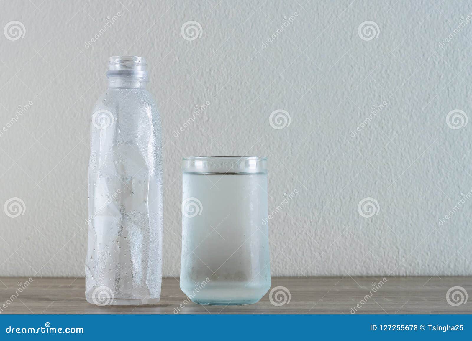 Glass of Water with Plastic Water Bottle on Wooden Table. Stock Photo ...