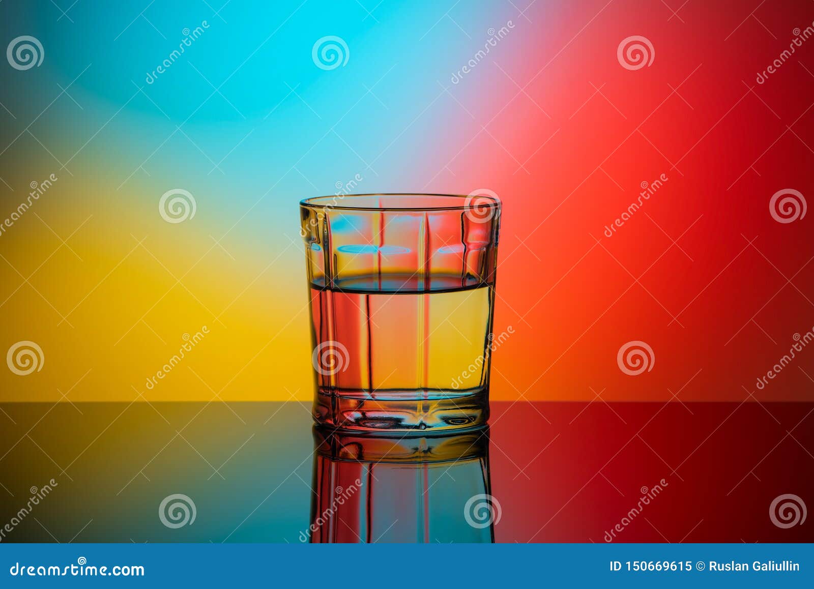 Glass of Water with Reflection on a Background of Bright Colored Light ...