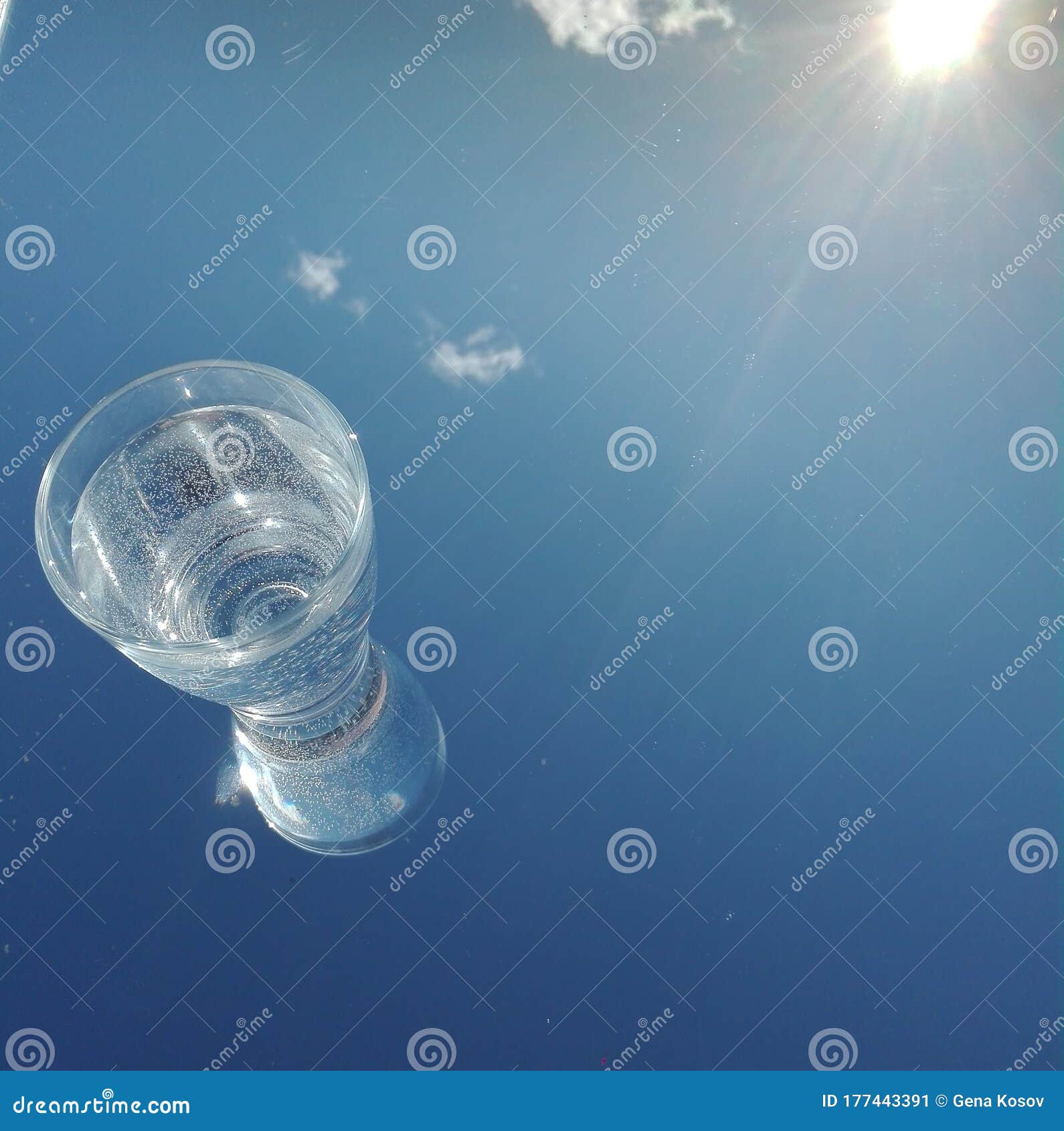 Glass of Water on Sky Background Reflection in the Mirror Stock Image ...
