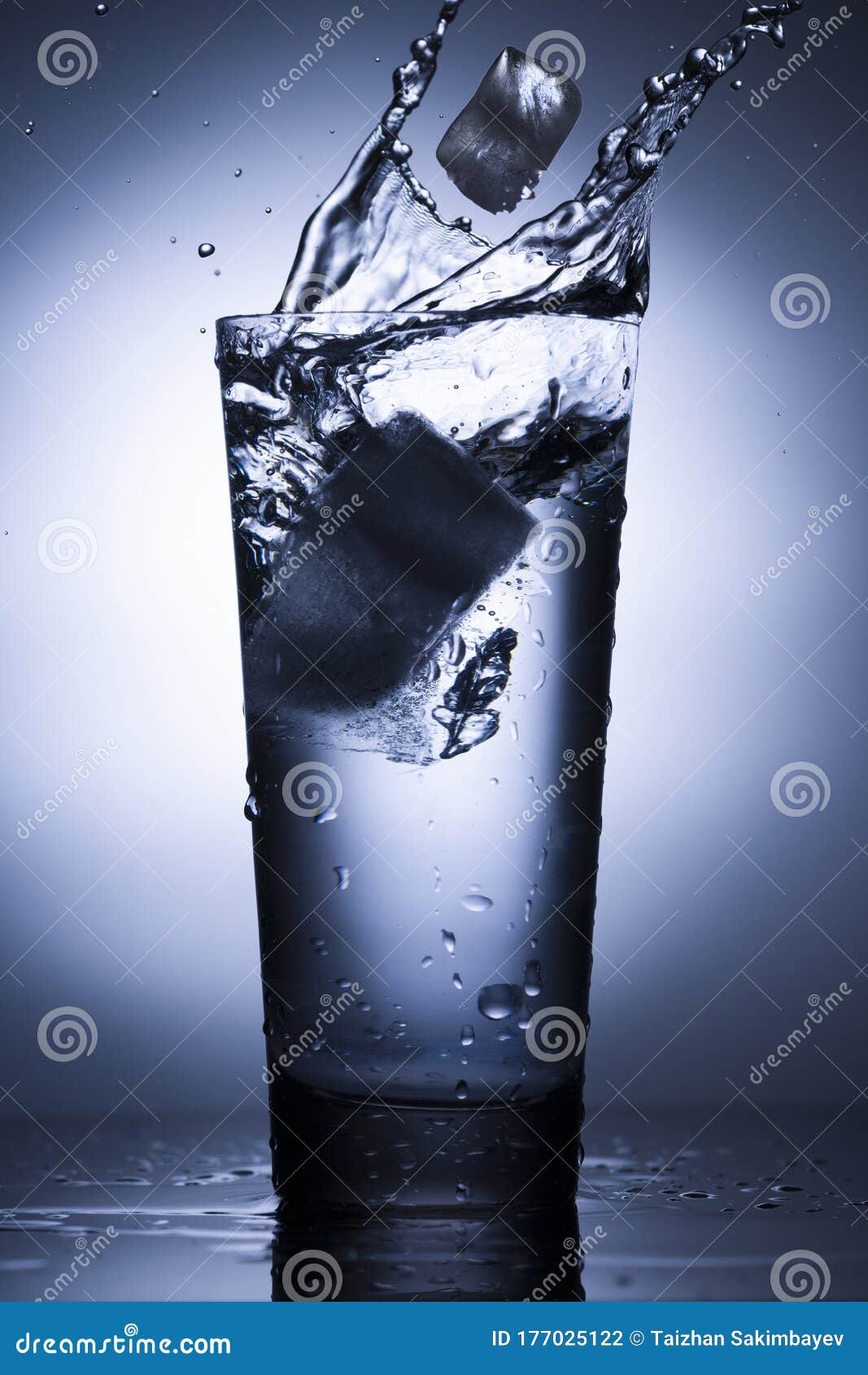 Glass of Water with Splash and Ice on Blue Background Stock Photo ...