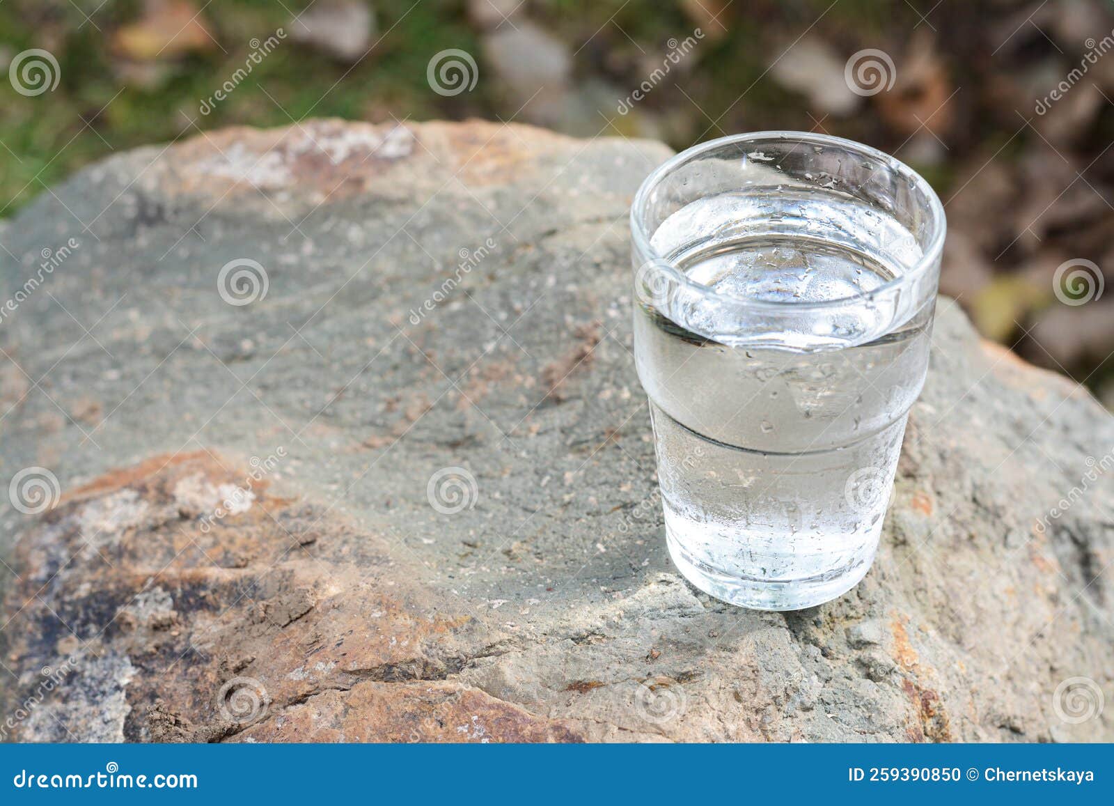Glass of Water on Stone Outdoors, Space for Text Stock Photo - Image of ...