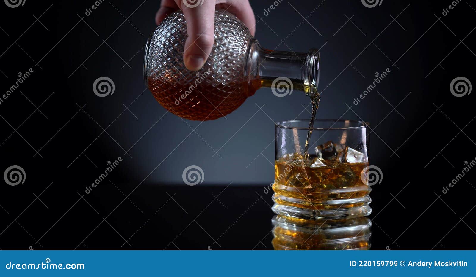 Glass of Whiskey with Ice Cube. Alcohol Pouring in the Glass from the ... Glass of Whiskey with Ice Cube. Alcohol Pouring in the Glass from the ...