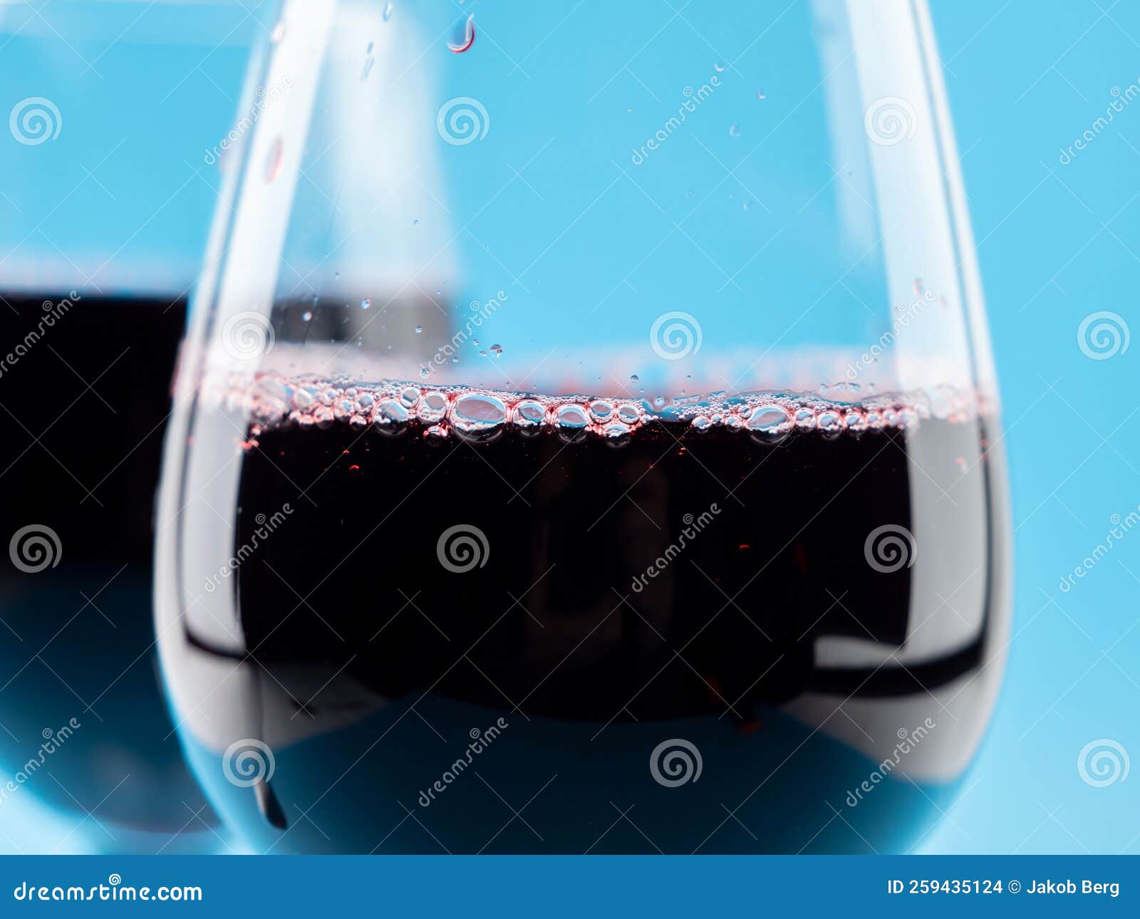 A Glass of Wine on a Blue Background. Stock Photo - Image of motion ...
