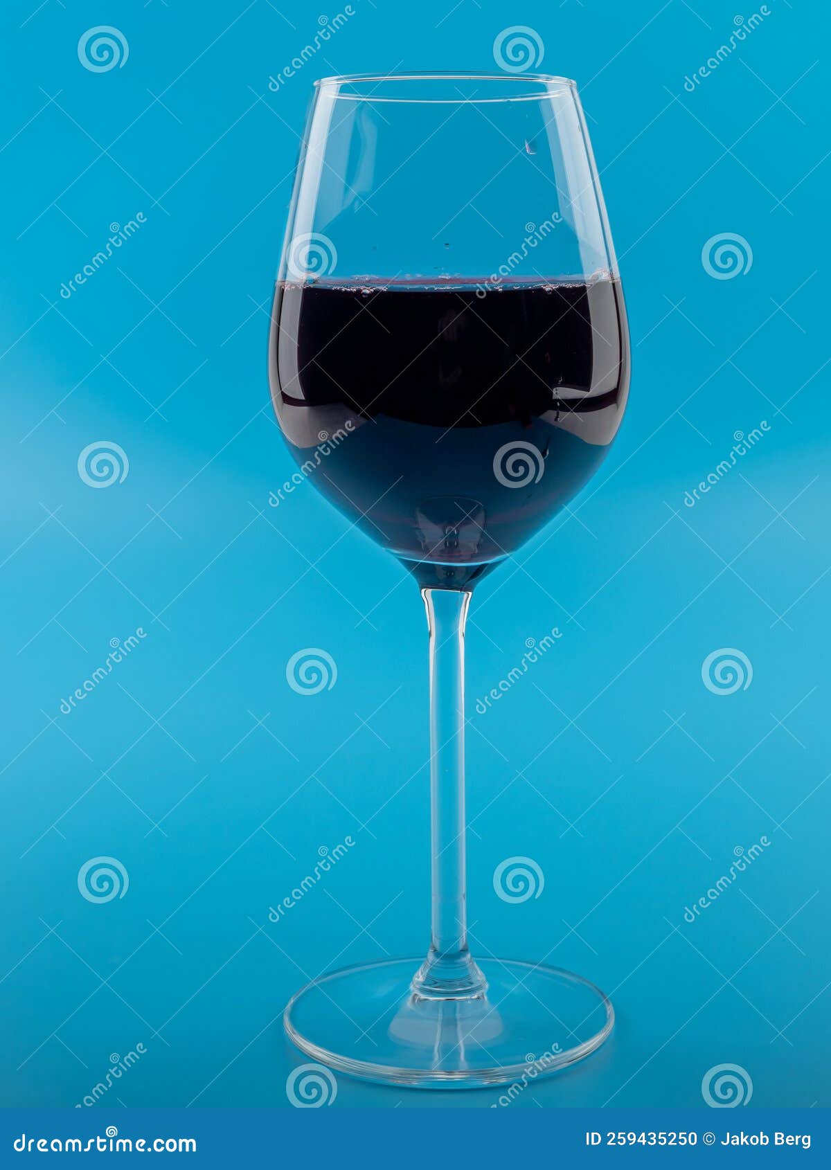 A Glass of Wine on a Blue Background. Stock Photo - Image of grape ...