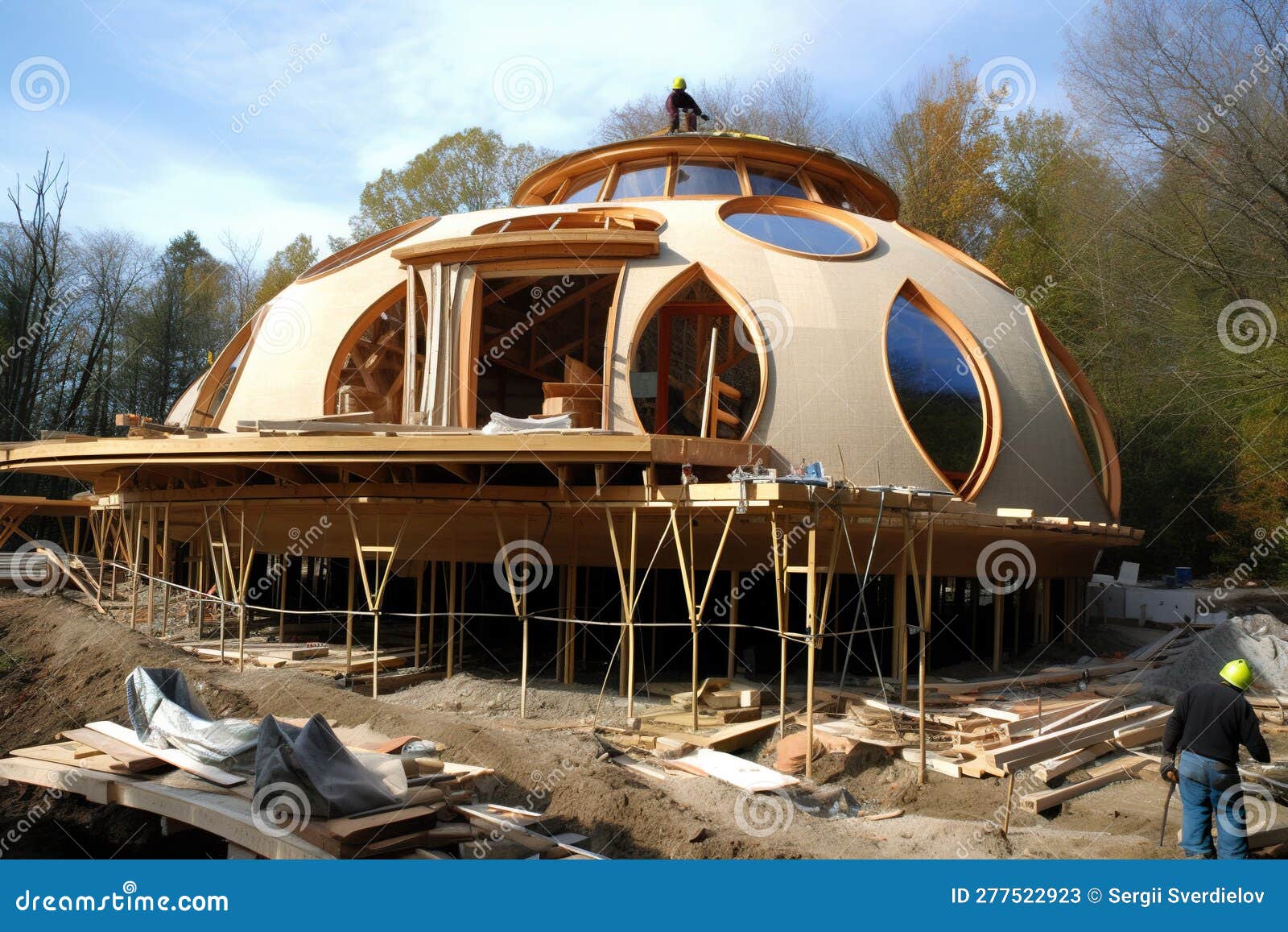A Glass and Wood Dome House Under Construction, with Scaffolding and ...