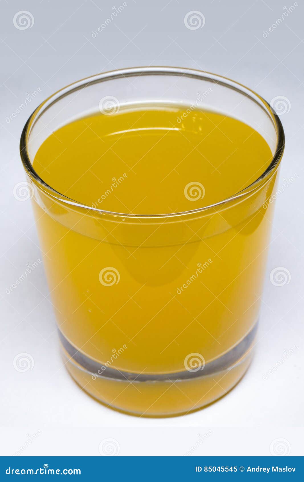 Glass with yellow liquid stock image. Image of drops - 85045545