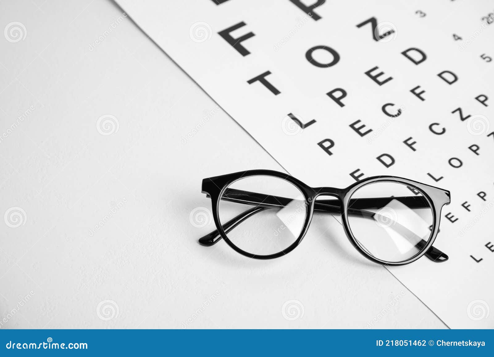 Glasses and Eye Chart Test on White Table, Space for Text ...