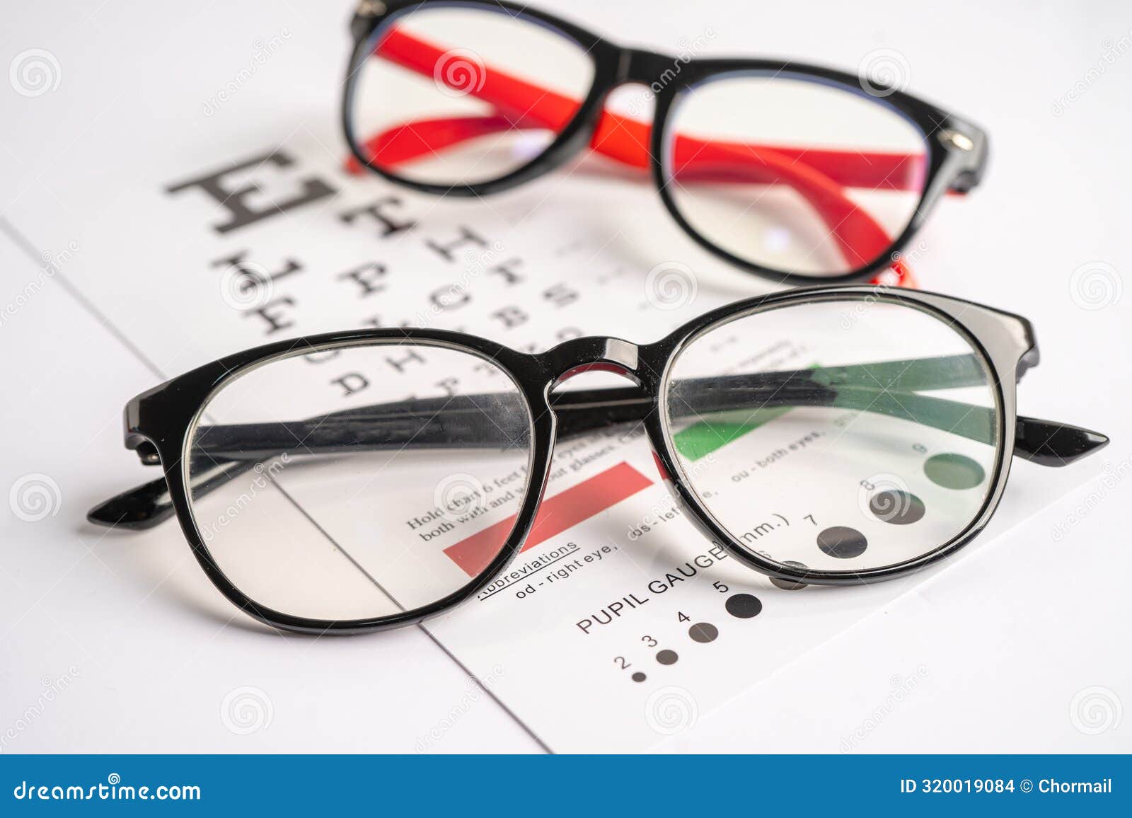 Glasses on Eye Testing Exam Chart To Check Eyesight Accuracy of Reading ...