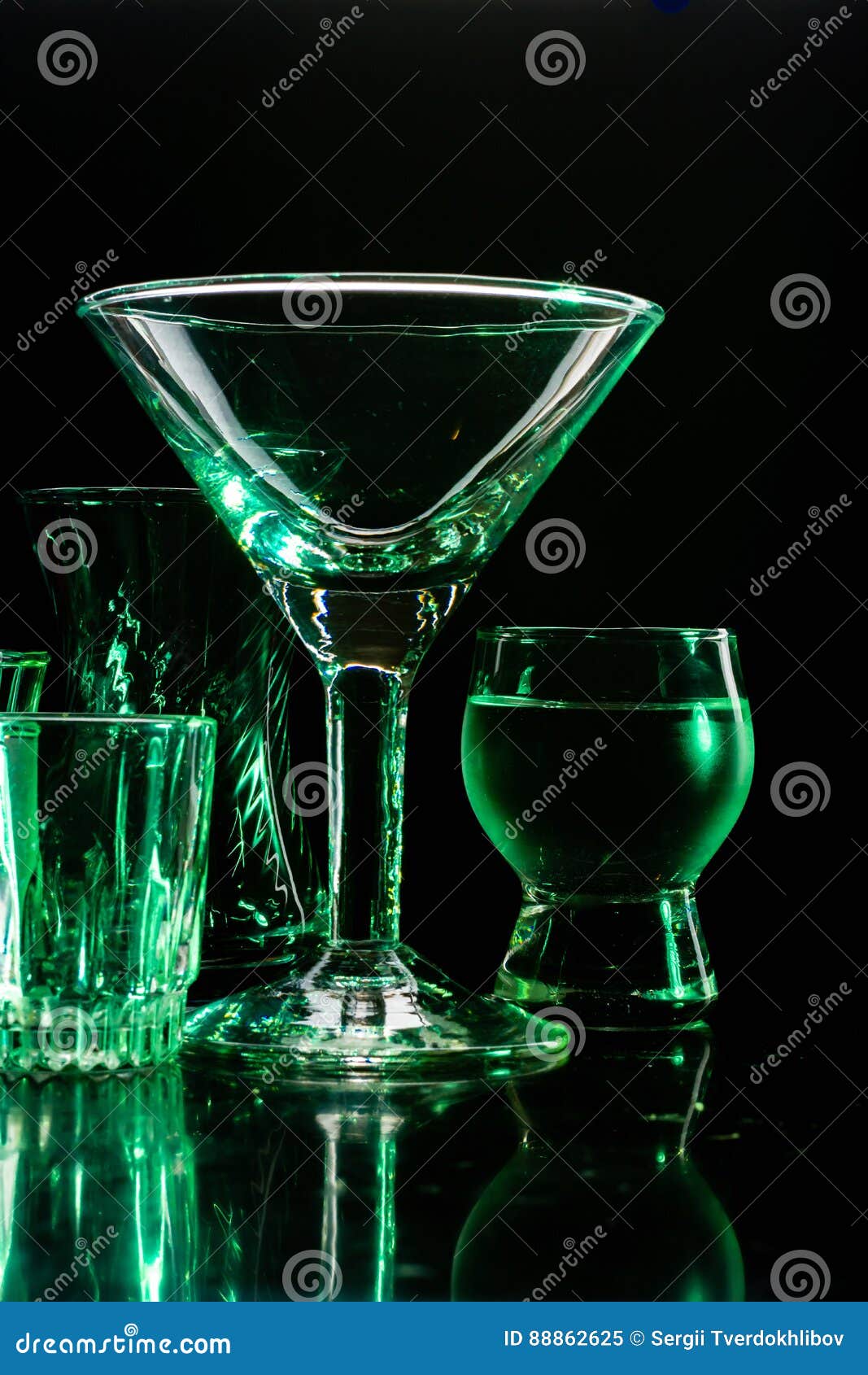 Glasses and Glasses Highlighted by Colored Light on a Black Background ...