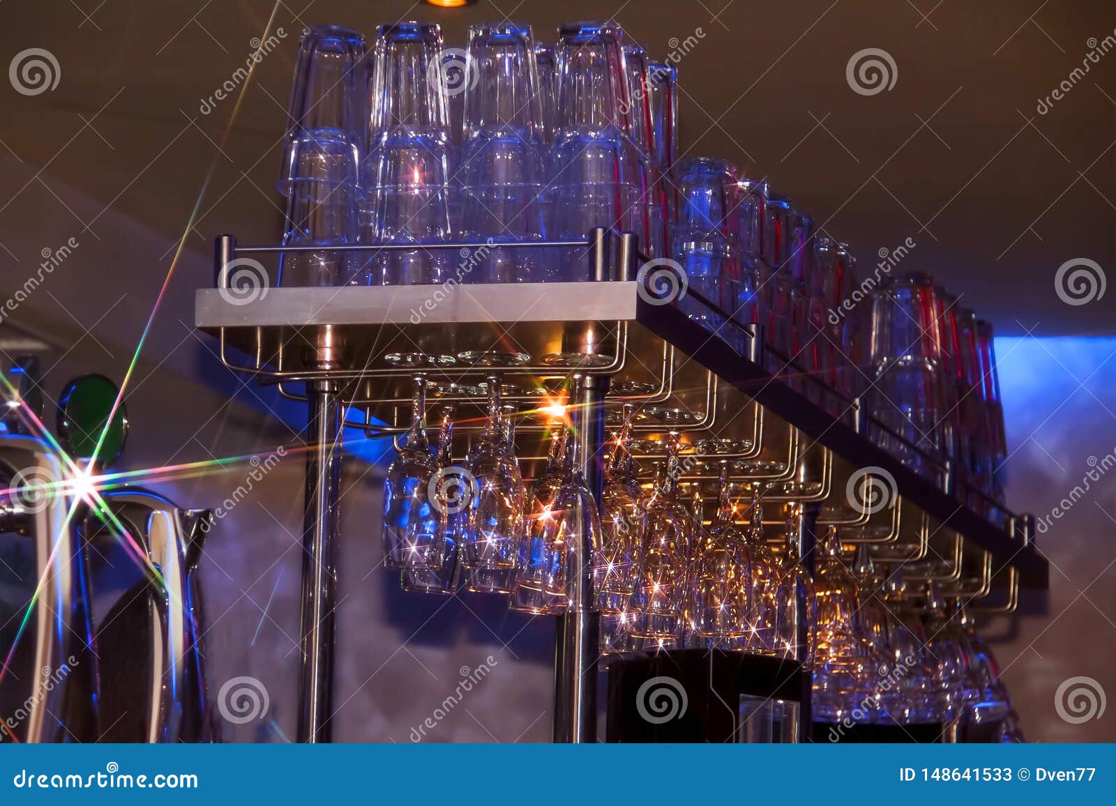Glasses hang over the bar stock image. Image of glowing - 148641533