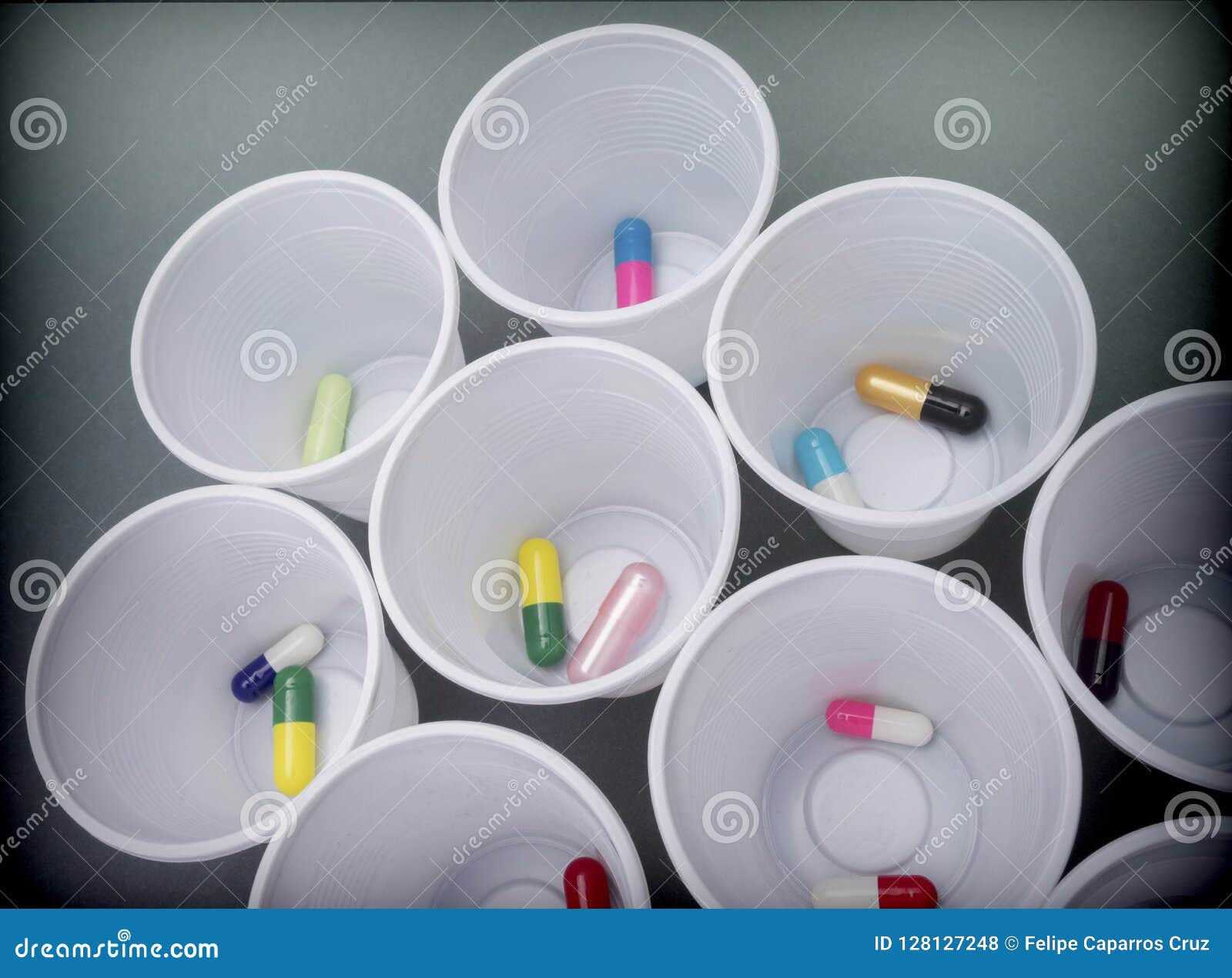 Glasses of Plastic White with daily Dose of Medication Stock Photo ...