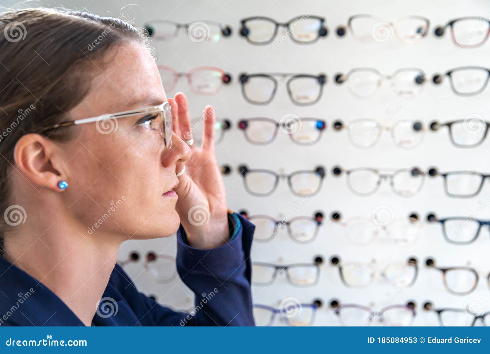 The Glasses are Selected and Tested by a Woman in an Optics Store. Copy ...