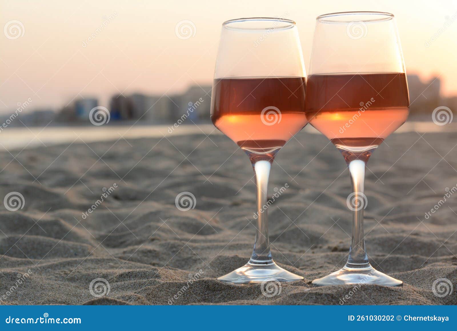 Glasses of Tasty Rose Wine on Sandy Beach, Space for Text Stock Photo ...