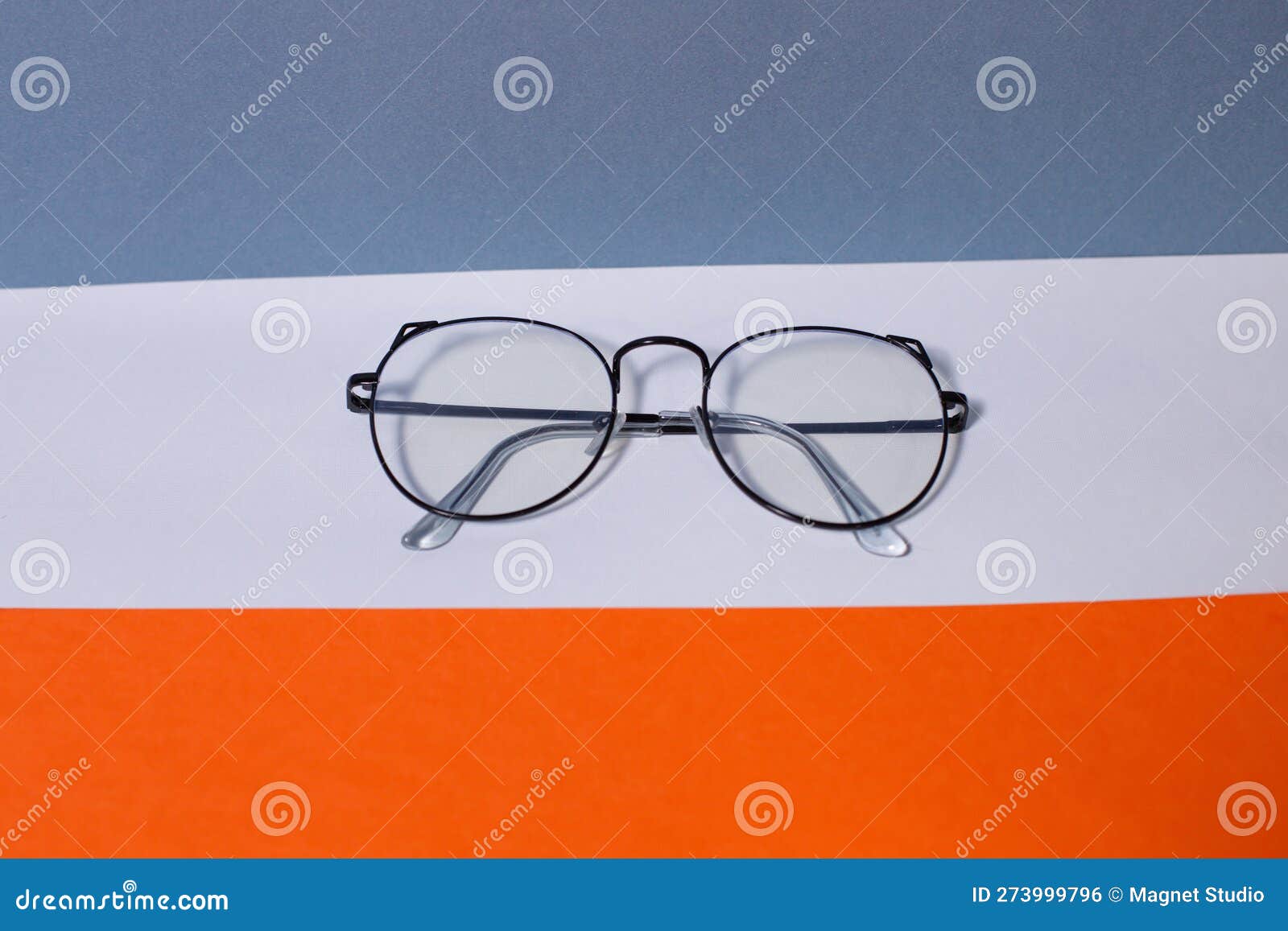 Glasses in a Thin Frame on a Background of Three Colors, Orange, Blue ...