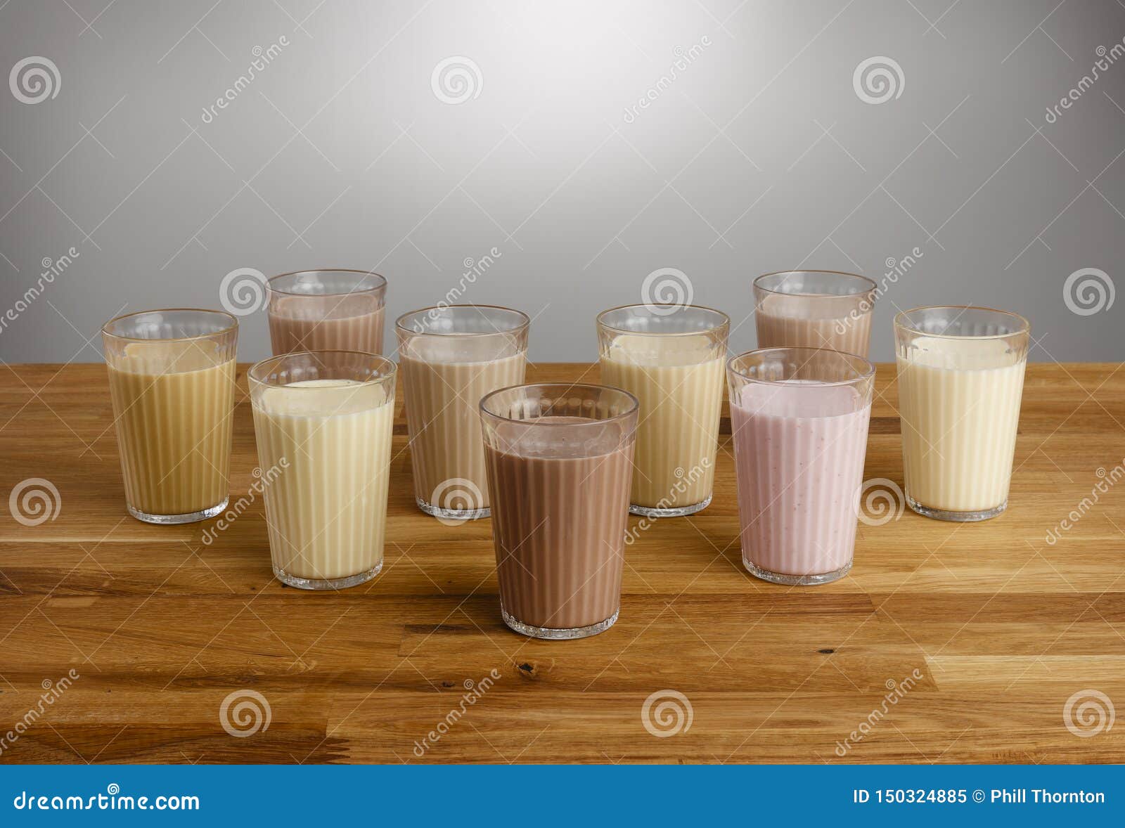 Glasses of Various Types of Milkshake on a Wooden Table Top Stock Image ...