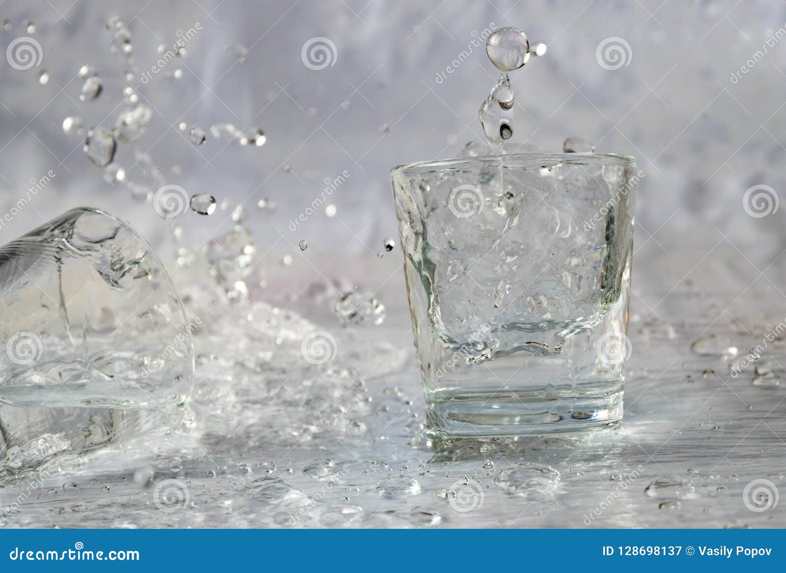 Glasses of Water Falling and Jumping with Splashes and Drops Stock ...
