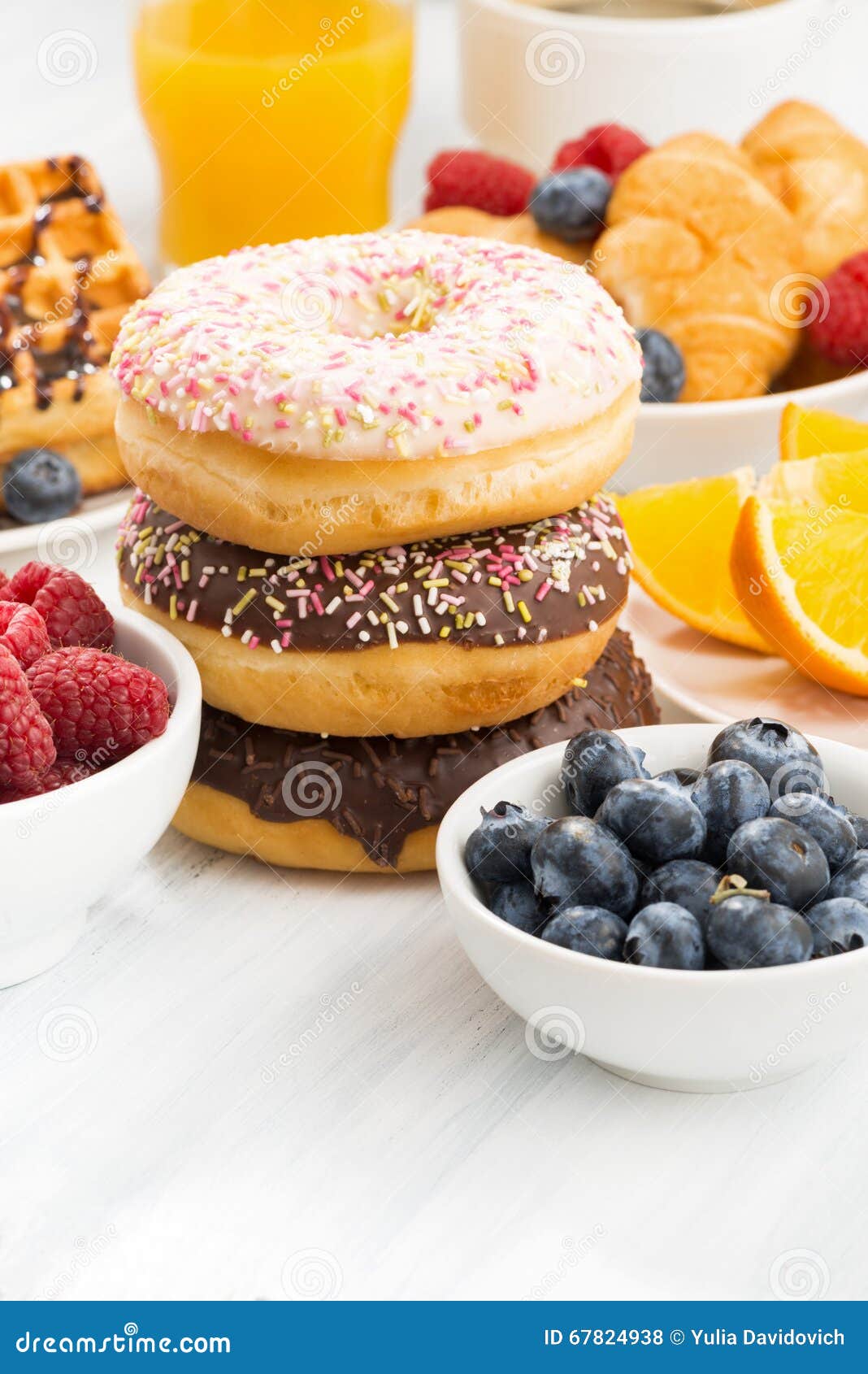 Glazed Donuts, Sweets and Fresh Berries on White Table, Vertical Stock ...
