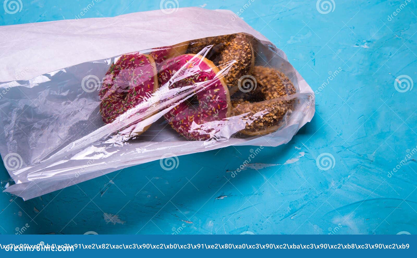 Glazed Doughnuts with Pink and Chocolate Icing with Sprinkles in a ...