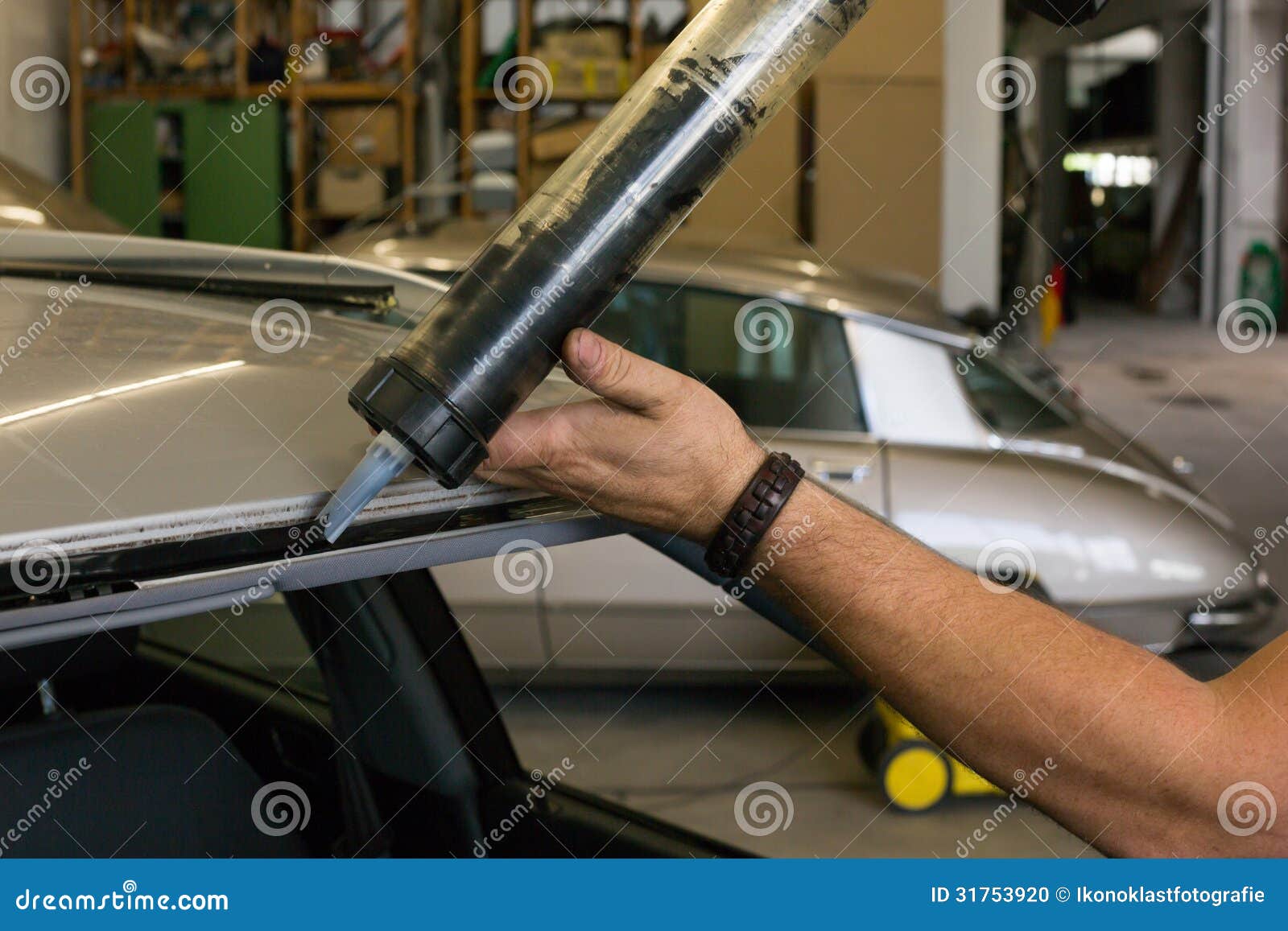 Glazier Using Application Gun To Apply Adhesive for Windscreen Stock ...