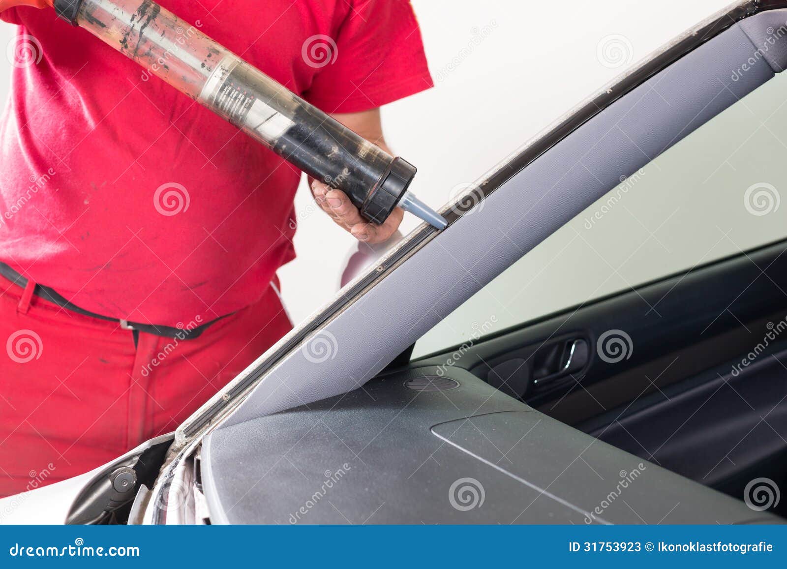 Glazier Using Application Gun To Apply Adhesive For Windscreen Stock ... Glazier Using Application Gun To Apply Adhesive For Windscreen Stock ...