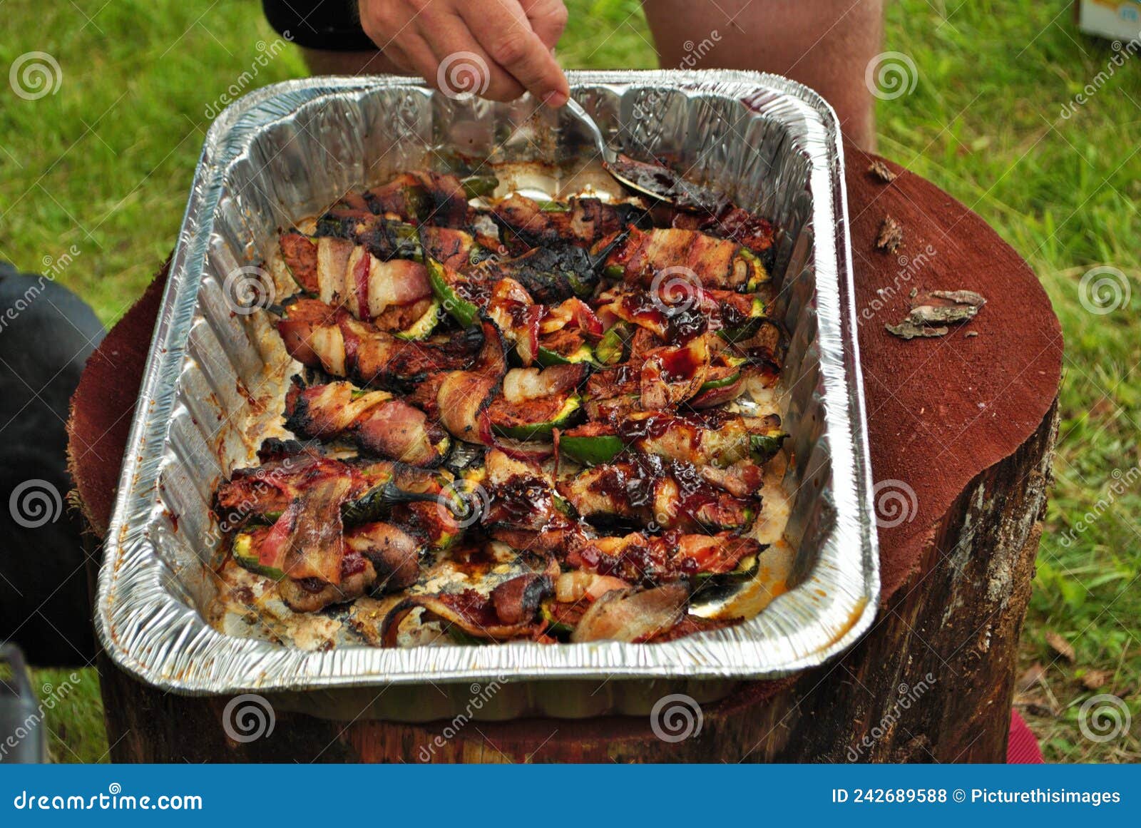 Glazing Cooked Bacon Wrapped Stuffed Jalapenos at a Cookout Stock Photo ...