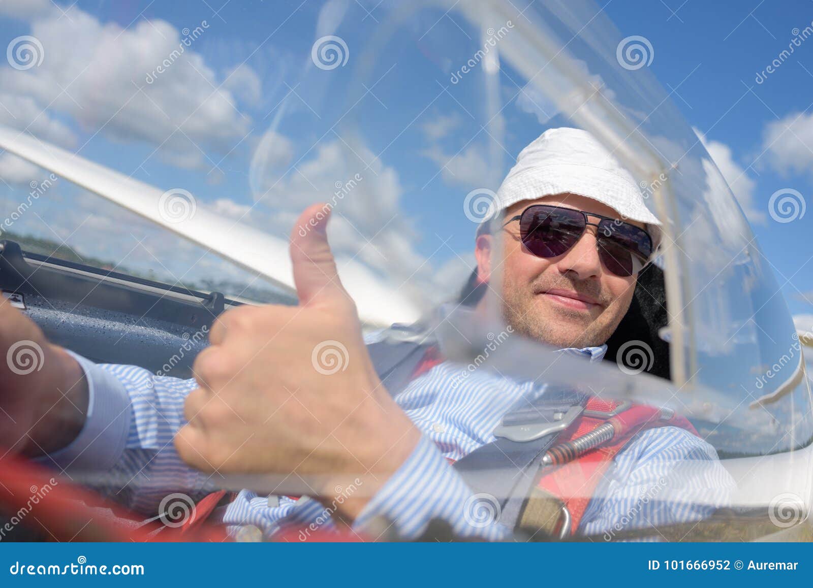 Glider pilot giving signal stock photo. Image of land - 101666952