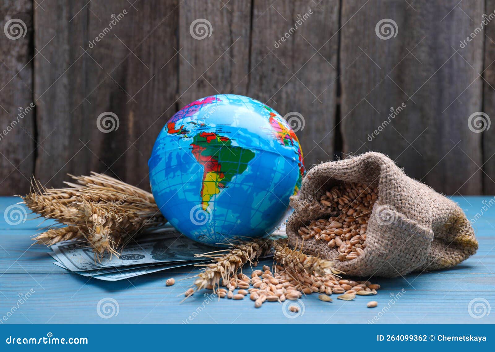 Globe and Bag of Wheat Grains on Light Blue Wooden Table. Import and ...