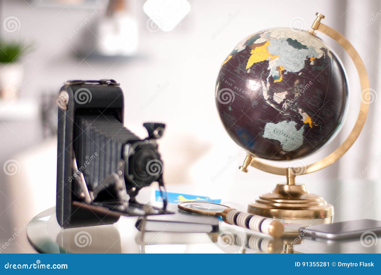 Globe and camera on table stock image. Image of glass - 91355281