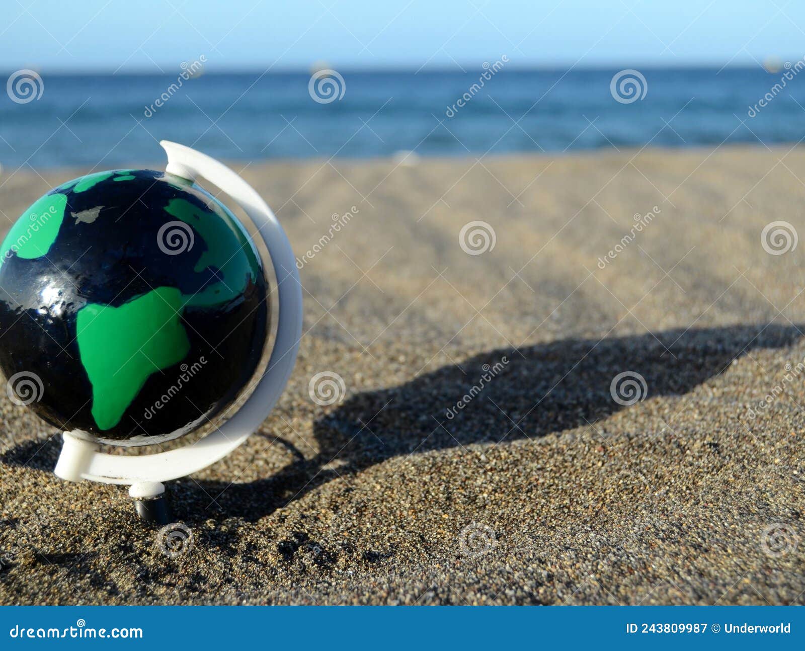 Globe Earth on the Beach stock image. Image of green - 243809987