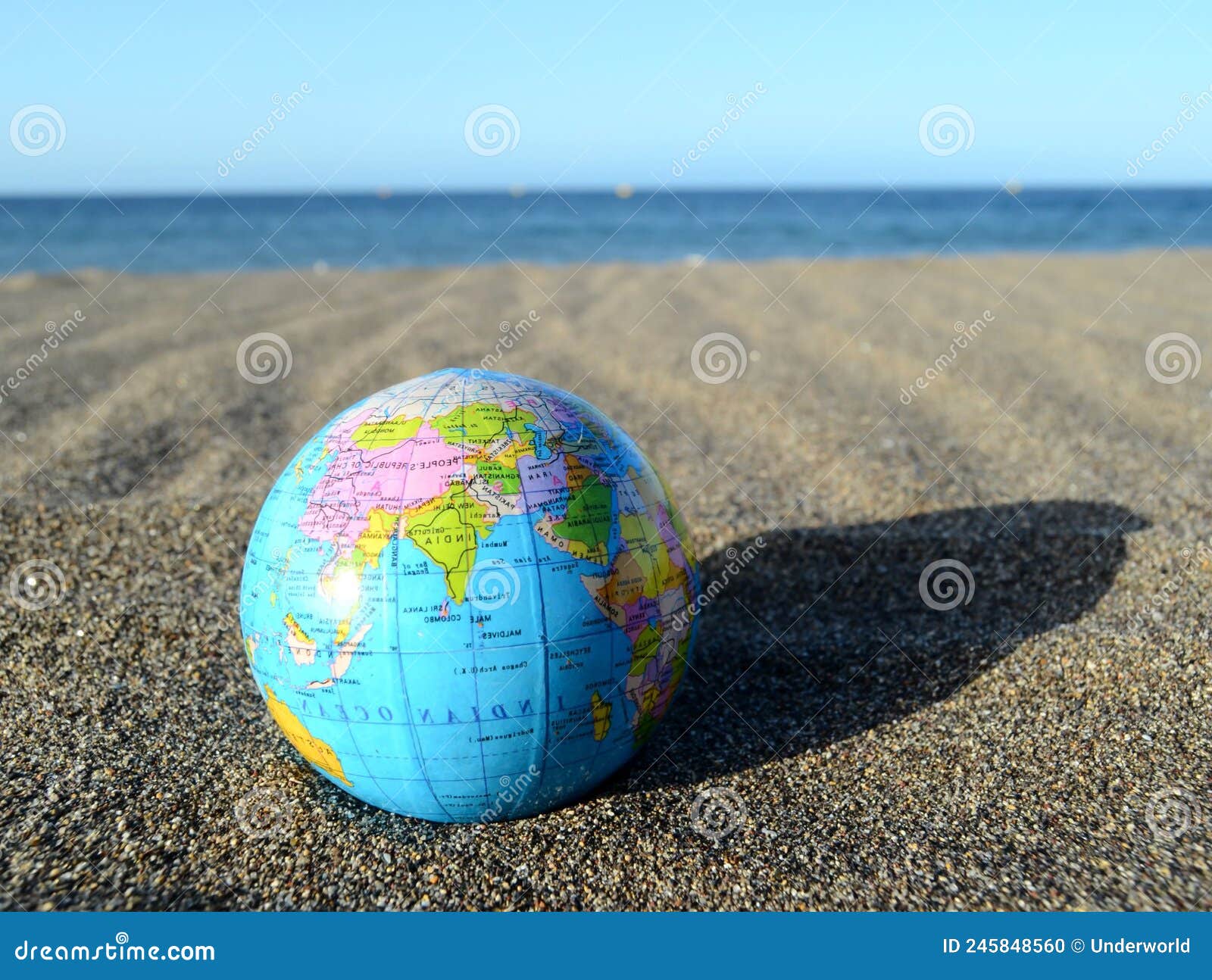 Globe Earth on the Beach stock photo. Image of beach - 245848560