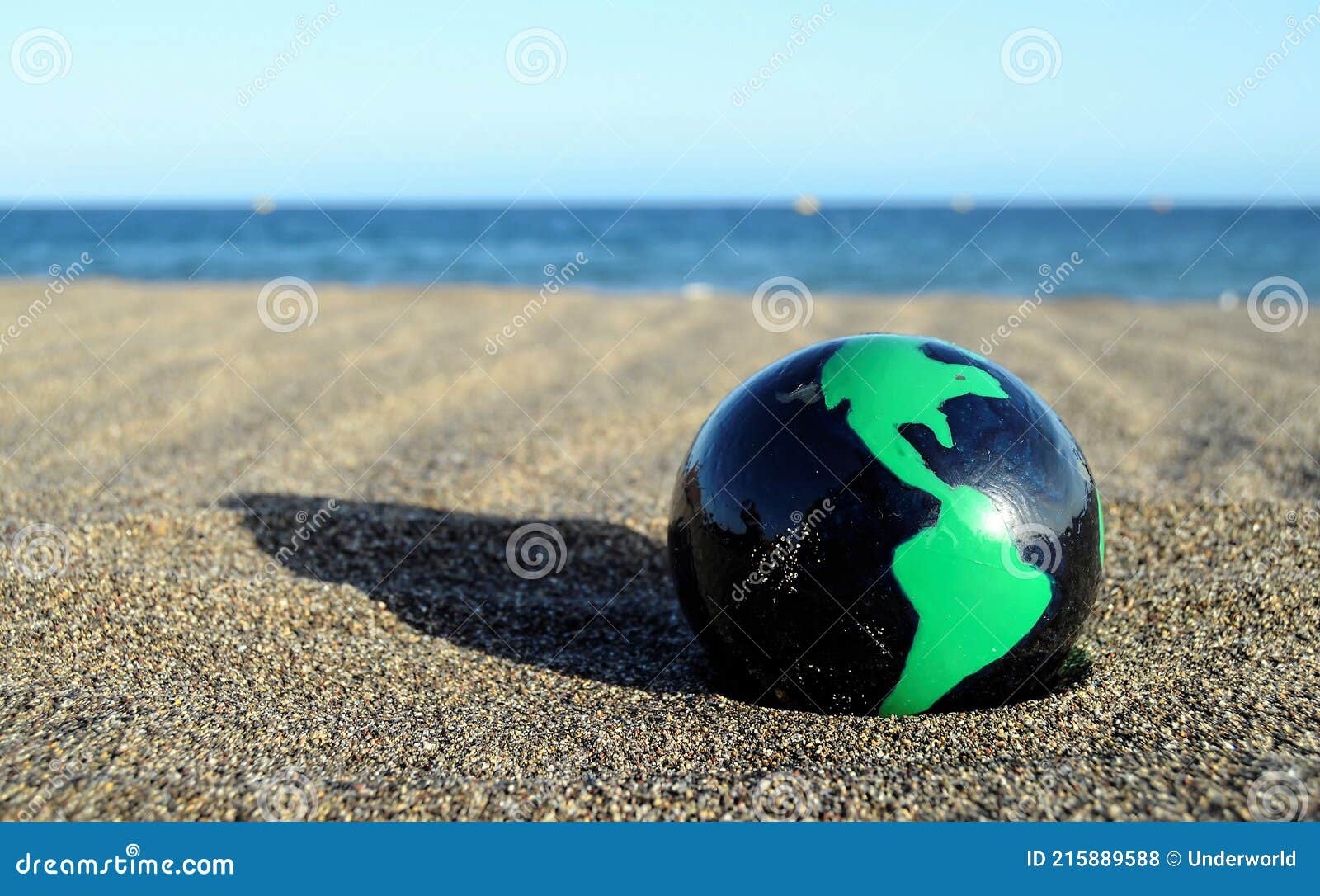 Globe Earth on the Beach stock photo. Image of sand - 215889588